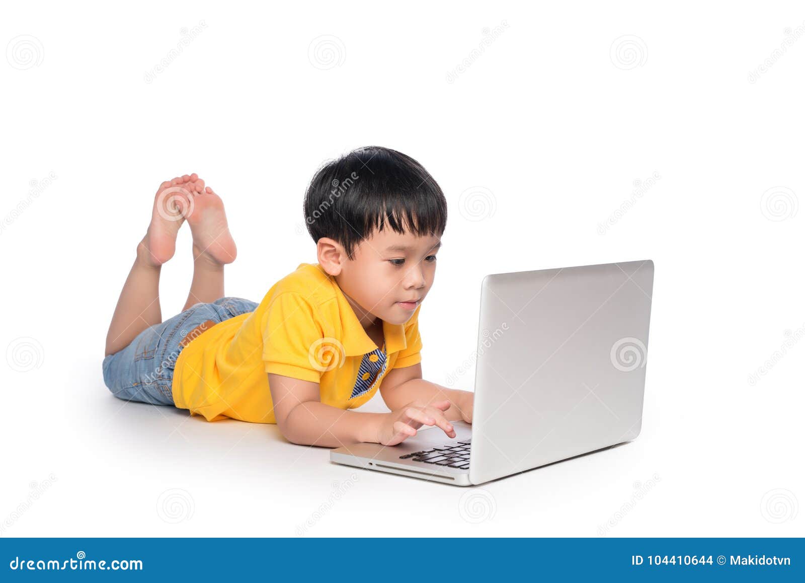 Schoolboy Lying Down and Typing on Laptop. Stock Photo - Image of ...