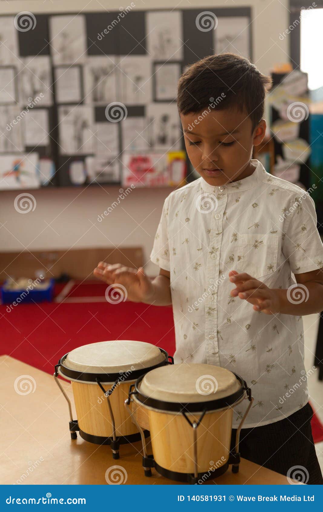 Schoolboy Playing Bongo in a Classroom Stock Image - Image of ...
