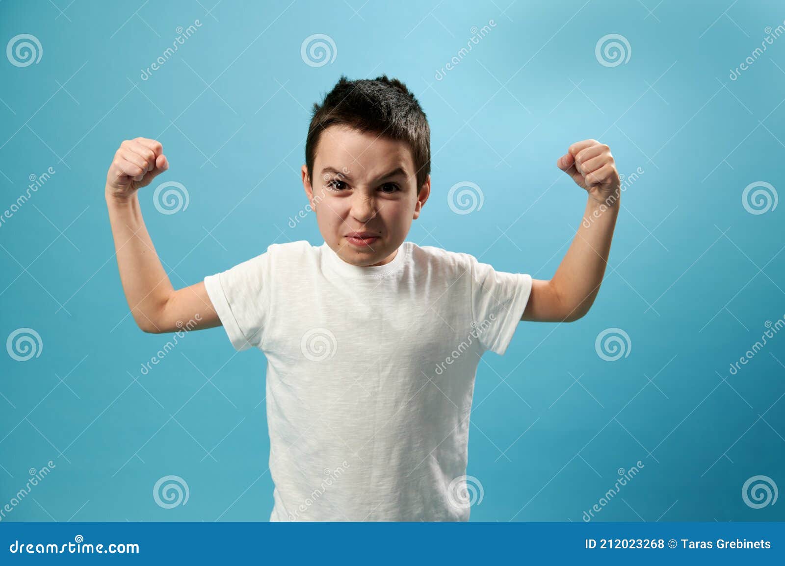 Schoolboy Pumping Biceps and Looking Angry To Camera on Blue Background ...