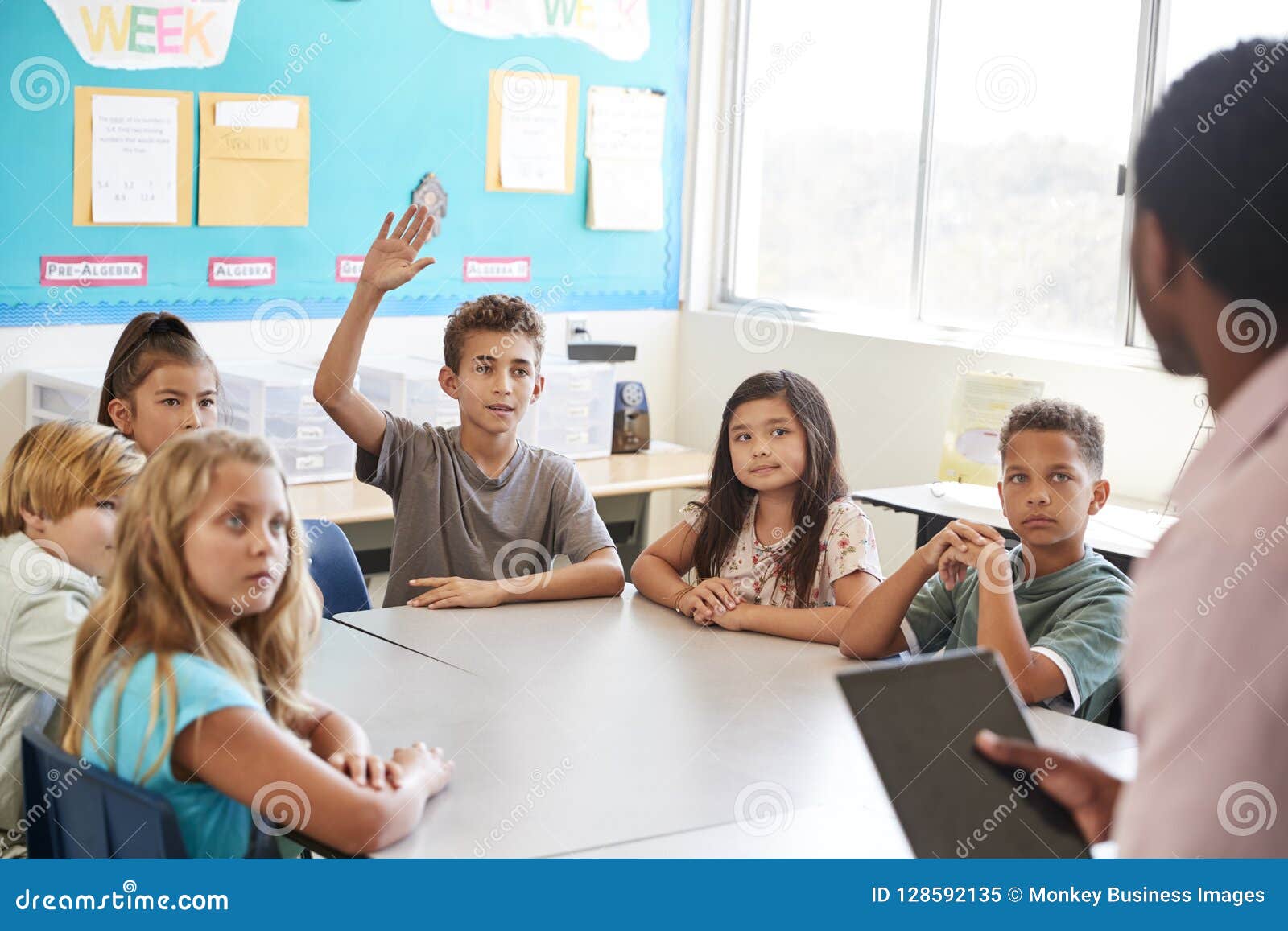Schoolboy Raising Hand To Answer in Elementary School Class Stock Image ...