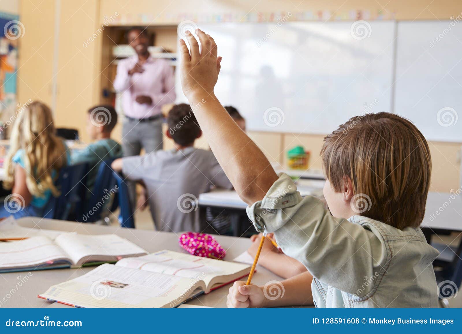 Schoolboy Raising Hand To Answer Question in a School Class Stock Photo ... Schoolboy Raising Hand To Answer Question in a School Class Stock Photo ...