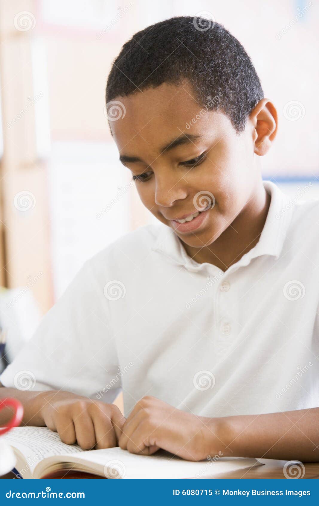 Schoolboy Reading a Book in Class Stock Image - Image of student ...