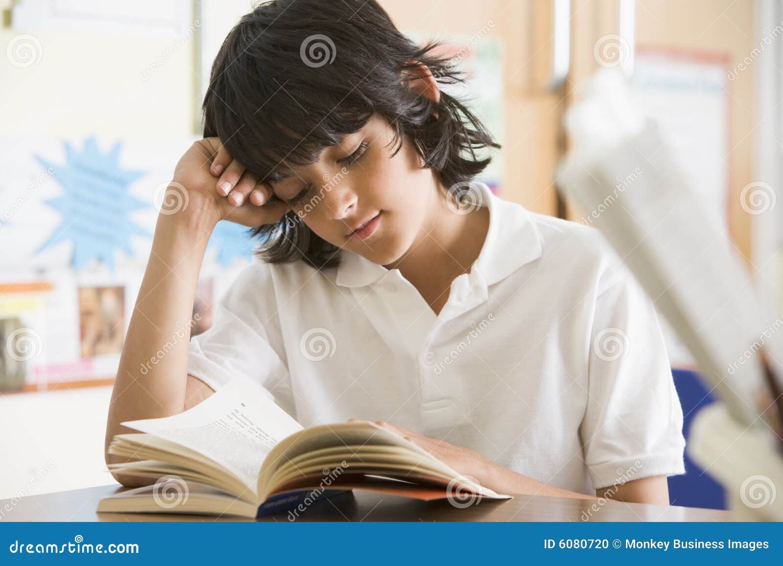 Schoolboy Reading a Book in Class Stock Photo - Image of indoors ...