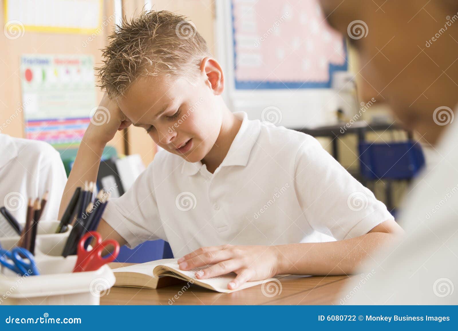 Schoolboy Reading a Book in Class Stock Photo - Image of concentration ...