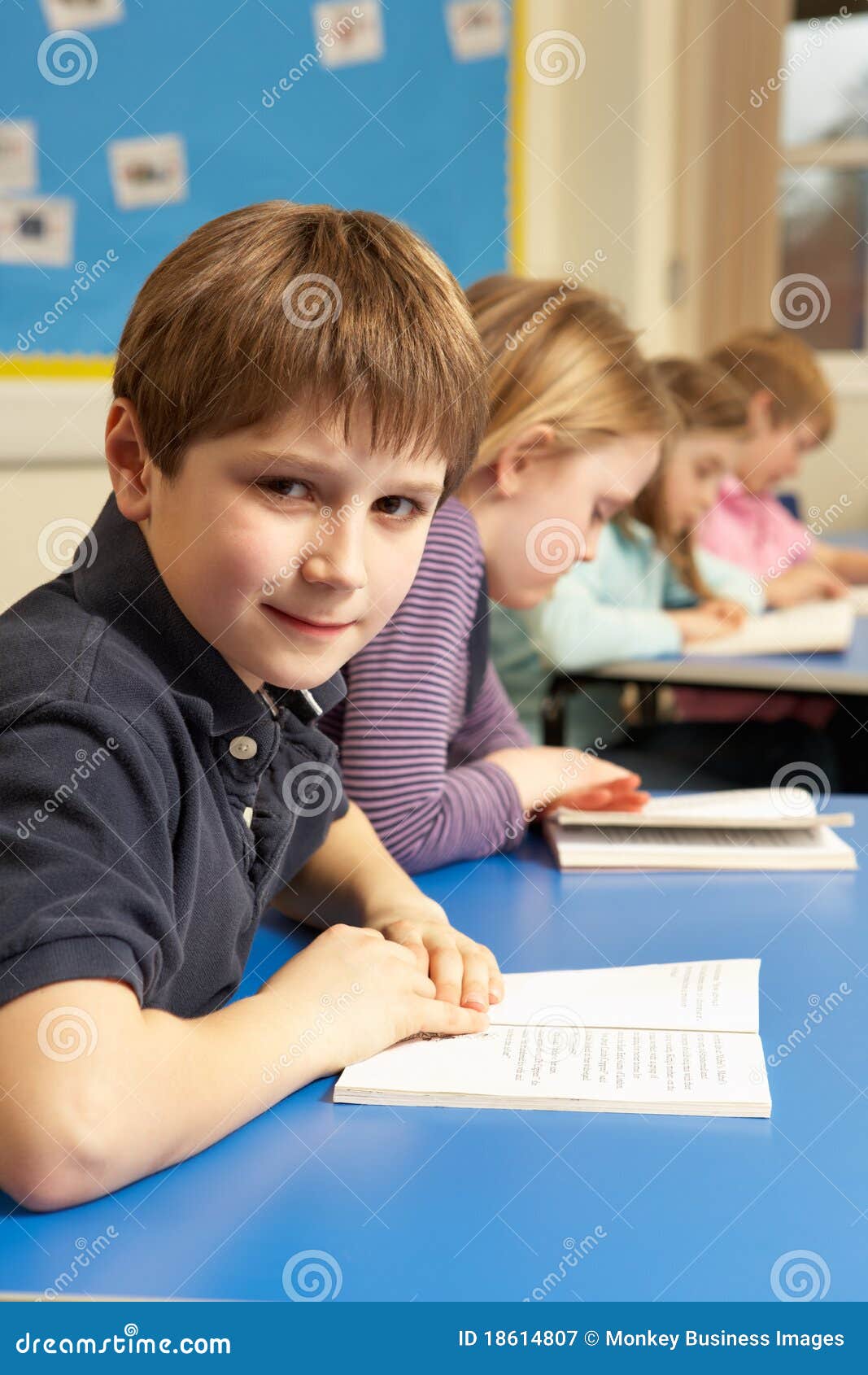 Schoolboy Reading Book in Classroom Stock Image - Image of casual ...