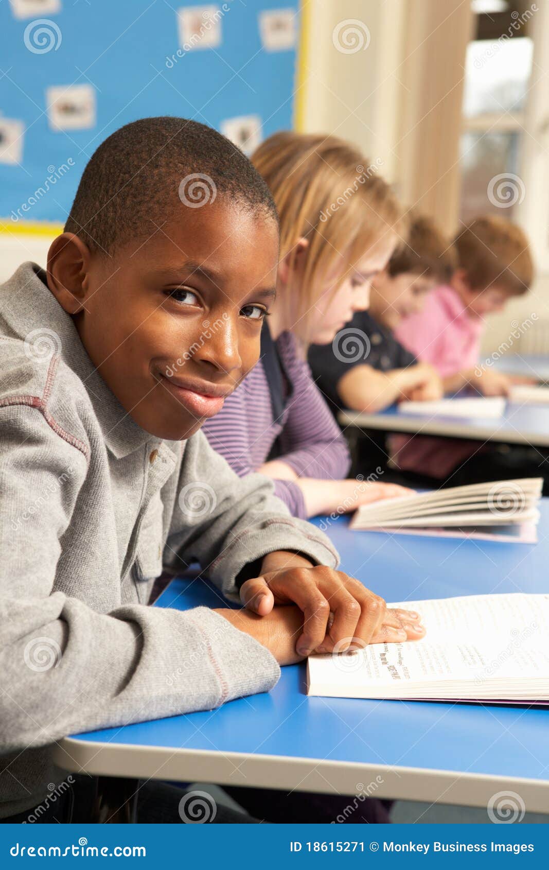 Schoolboy Reading Book in Classroom Stock Image - Image of junior ...