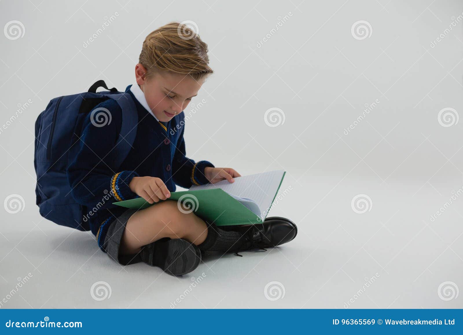 Schoolboy Reading Book while Sitting on White Background Stock Image ...