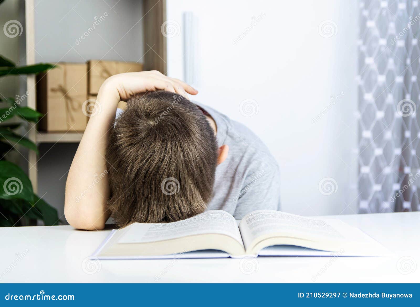 The Schoolboy`s Boy Put His Head On The Table At The Open Book. The ...