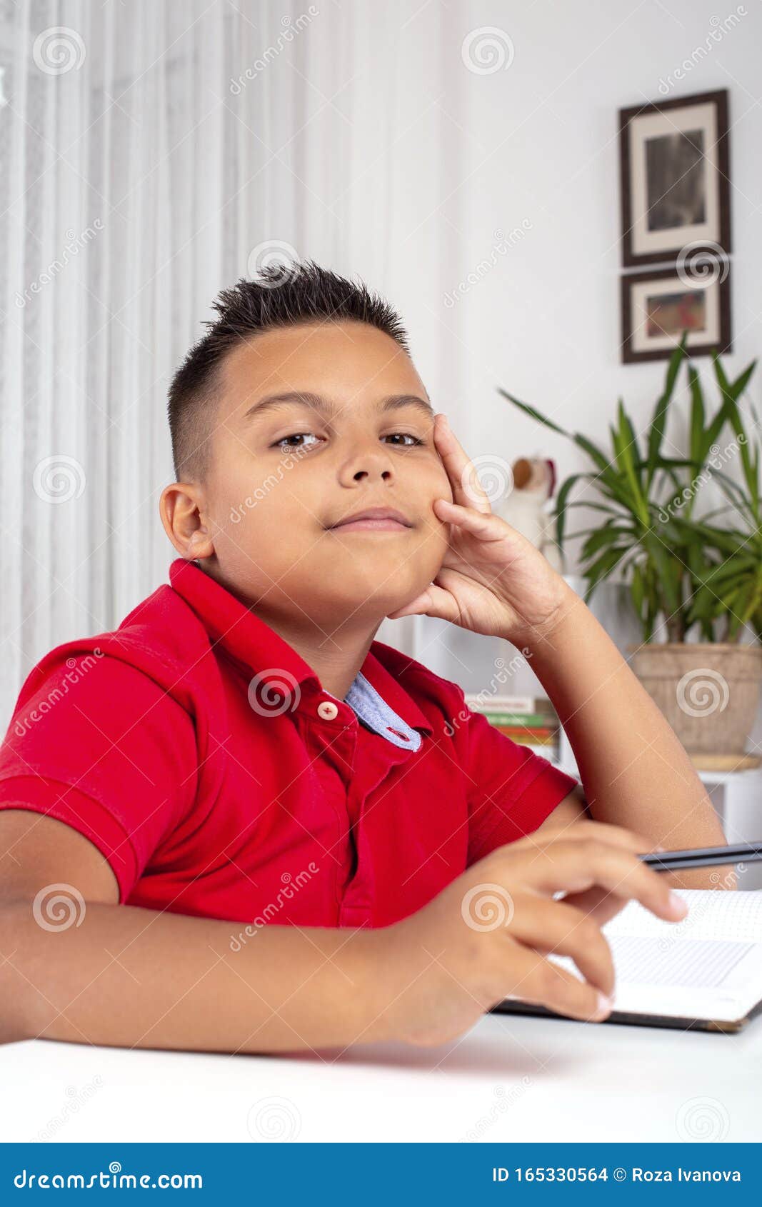 The Schoolboy Sits at the Table Indoors and Do Their Homework Stock ...