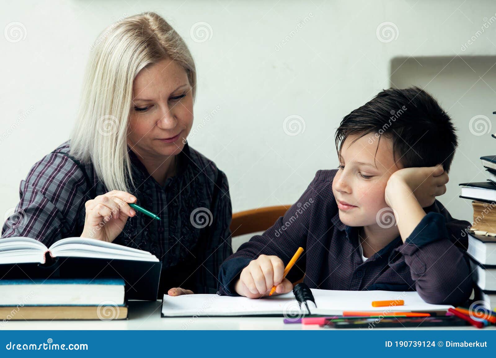 Schoolboy and Tutor Sits at a Table Does Homework. Stock Photo - Image ...