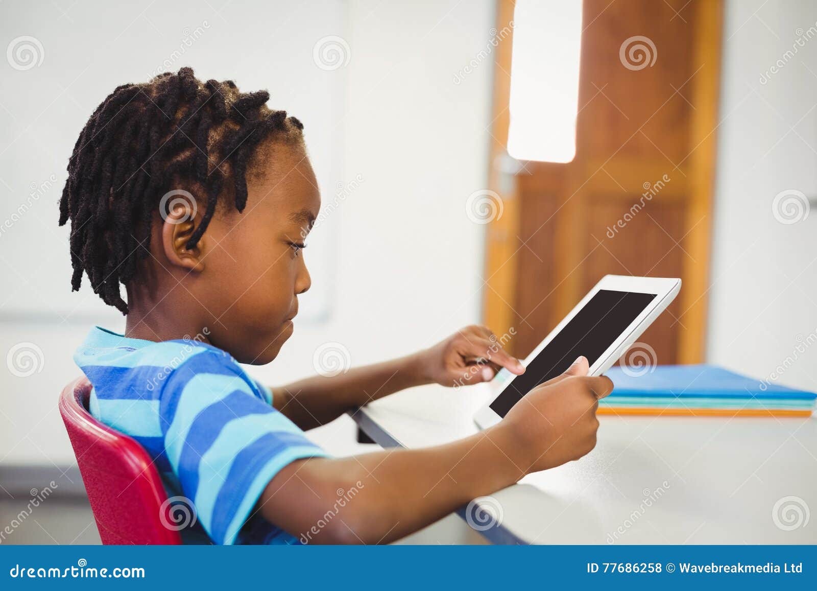 Schoolboy Using Digital Tablet in Classroom Stock Photo - Image of ...