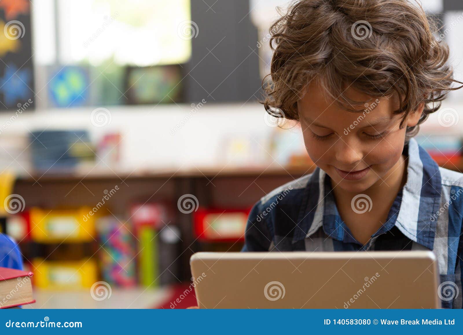 Schoolboy Using Digital Tablet in the Library Stock Photo - Image of ...