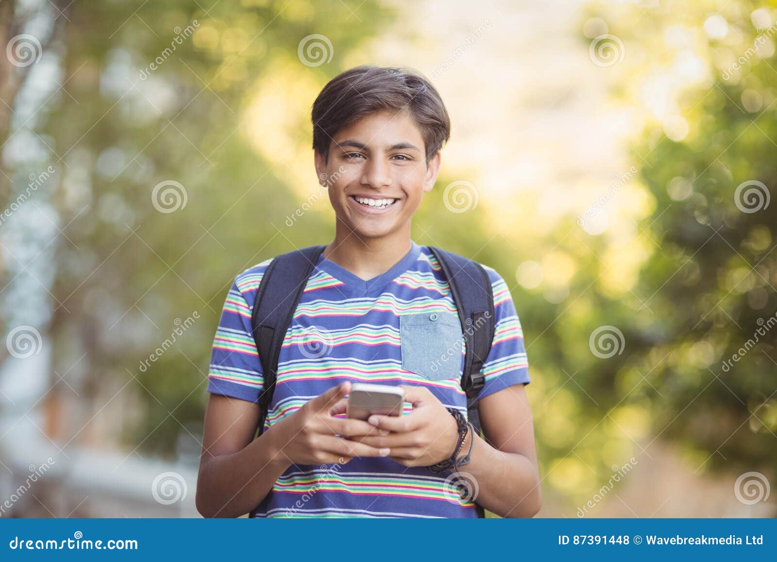 Schoolboy Using Mobile Phone in Campus at School Stock Photo - Image of ...