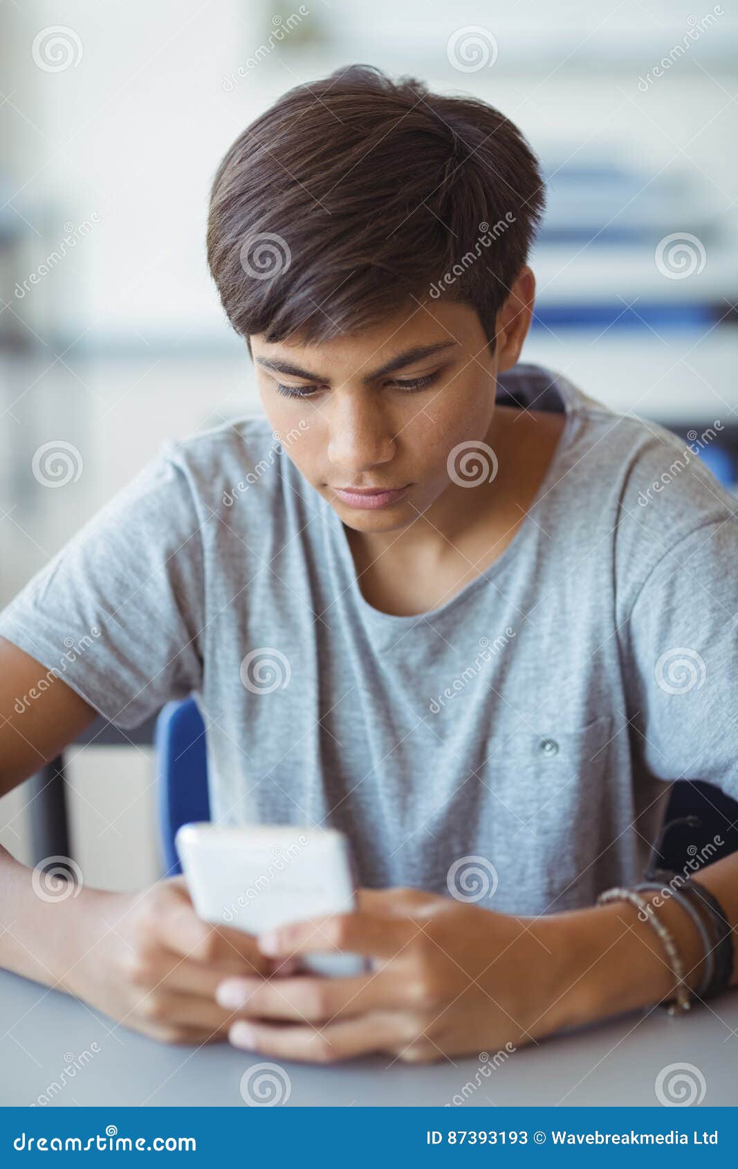 Schoolboy Using Mobile Phone in Classroom Stock Image - Image of ...