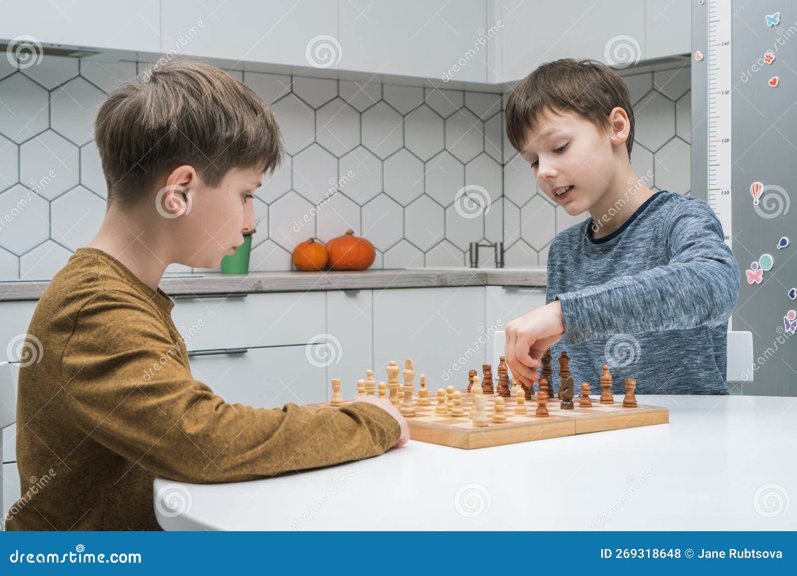 Schoolboys Play Chess on Kitchen Table, Side View. Chessboard with ...