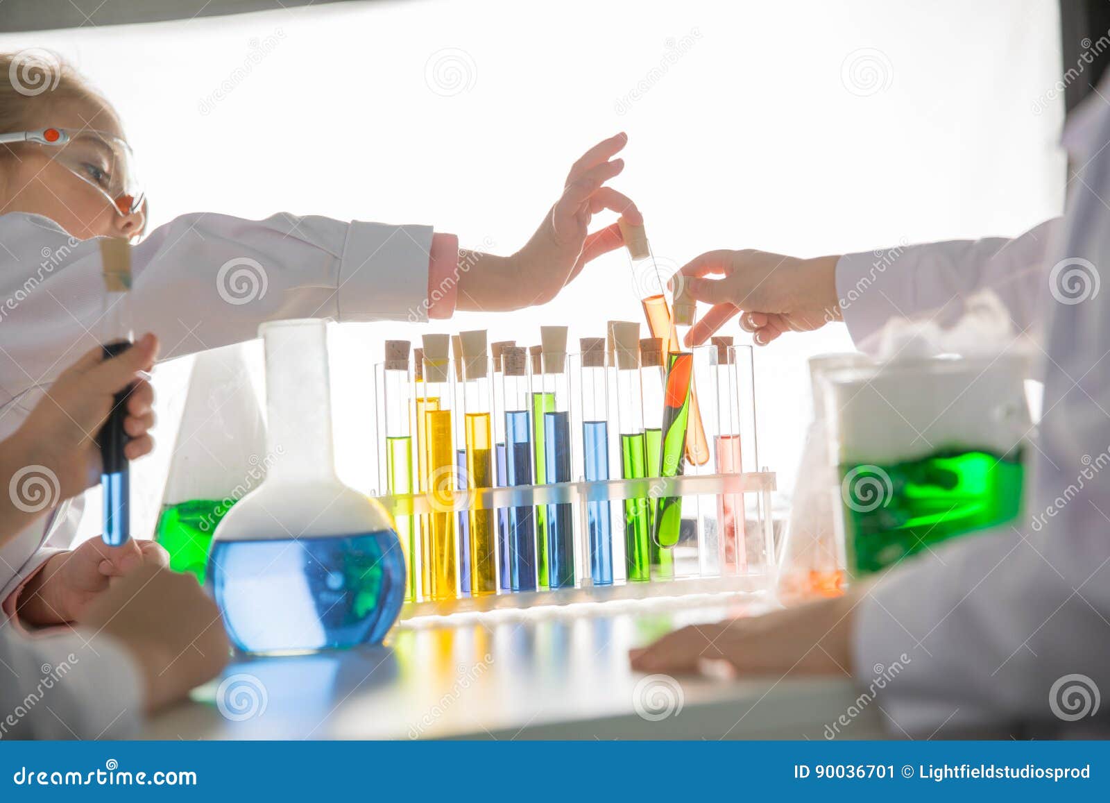 Schoolchildren in Lab Coats Making Experiment with Test Tubes Stock ...