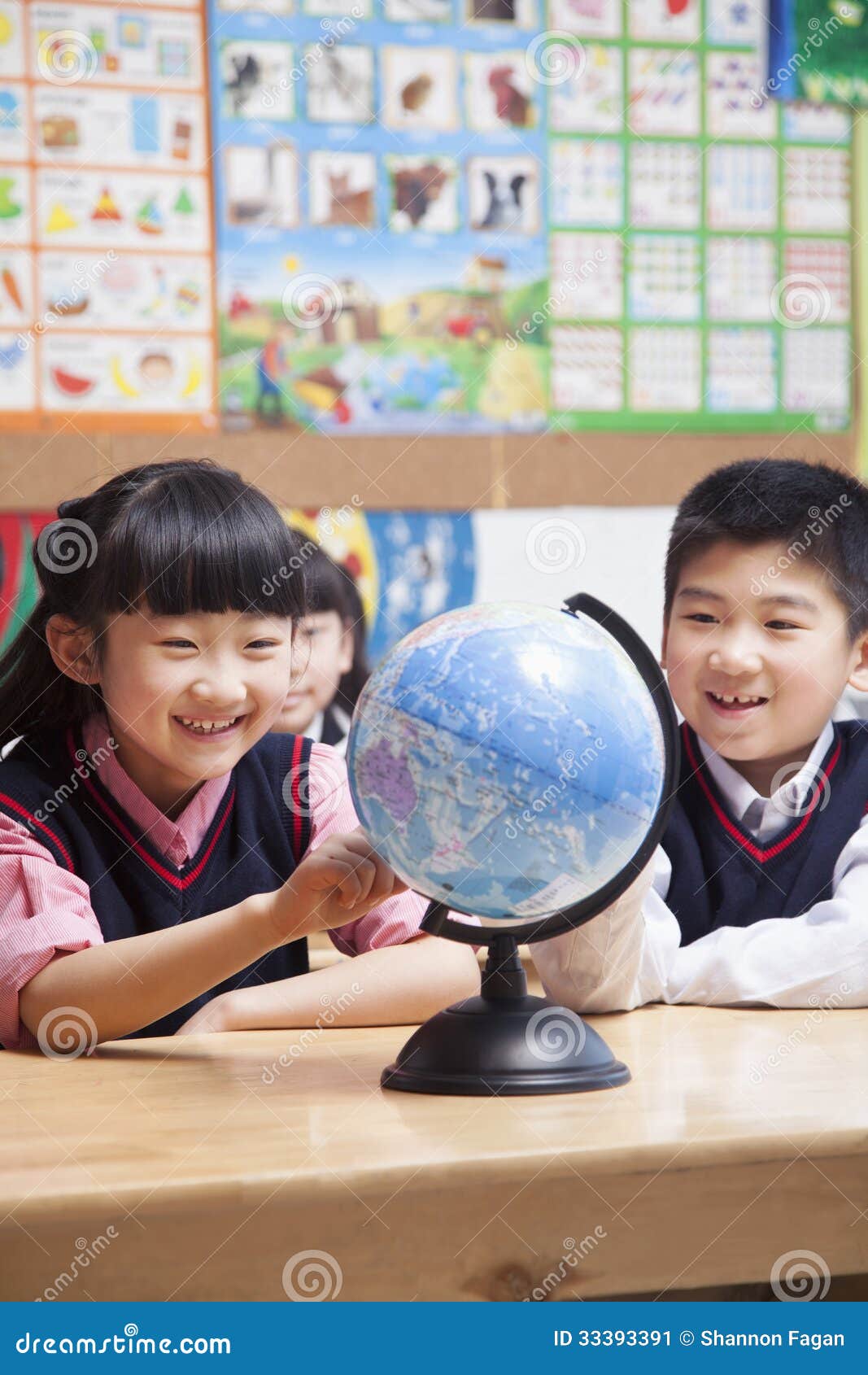 Schoolchildren Looking at a Globe in the Classroom Stock Image - Image ... Schoolchildren Looking at a Globe in the Classroom Stock Image - Image ...