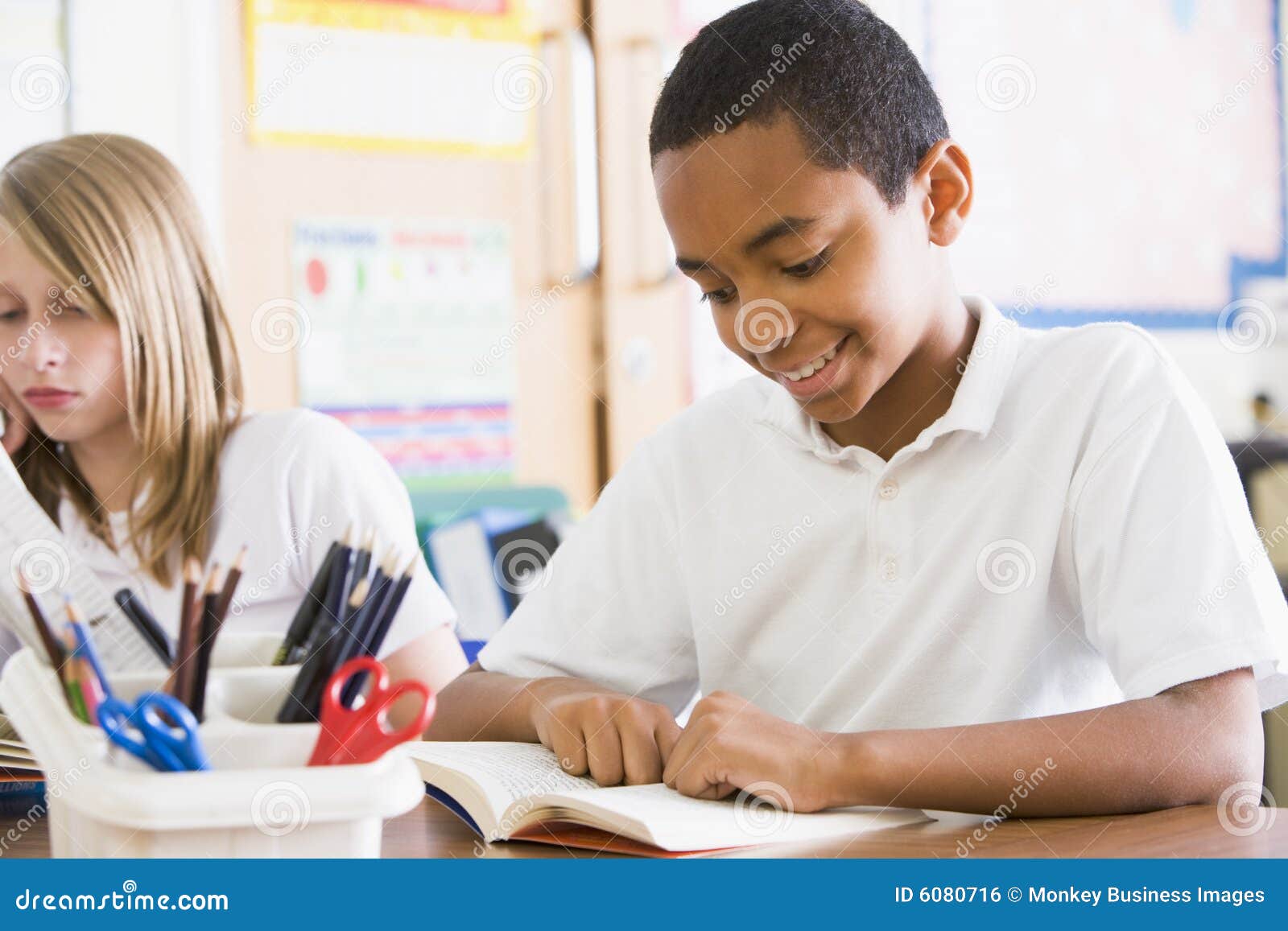 Schoolchildren Reading Books in Class Stock Photo - Image of mixed ...