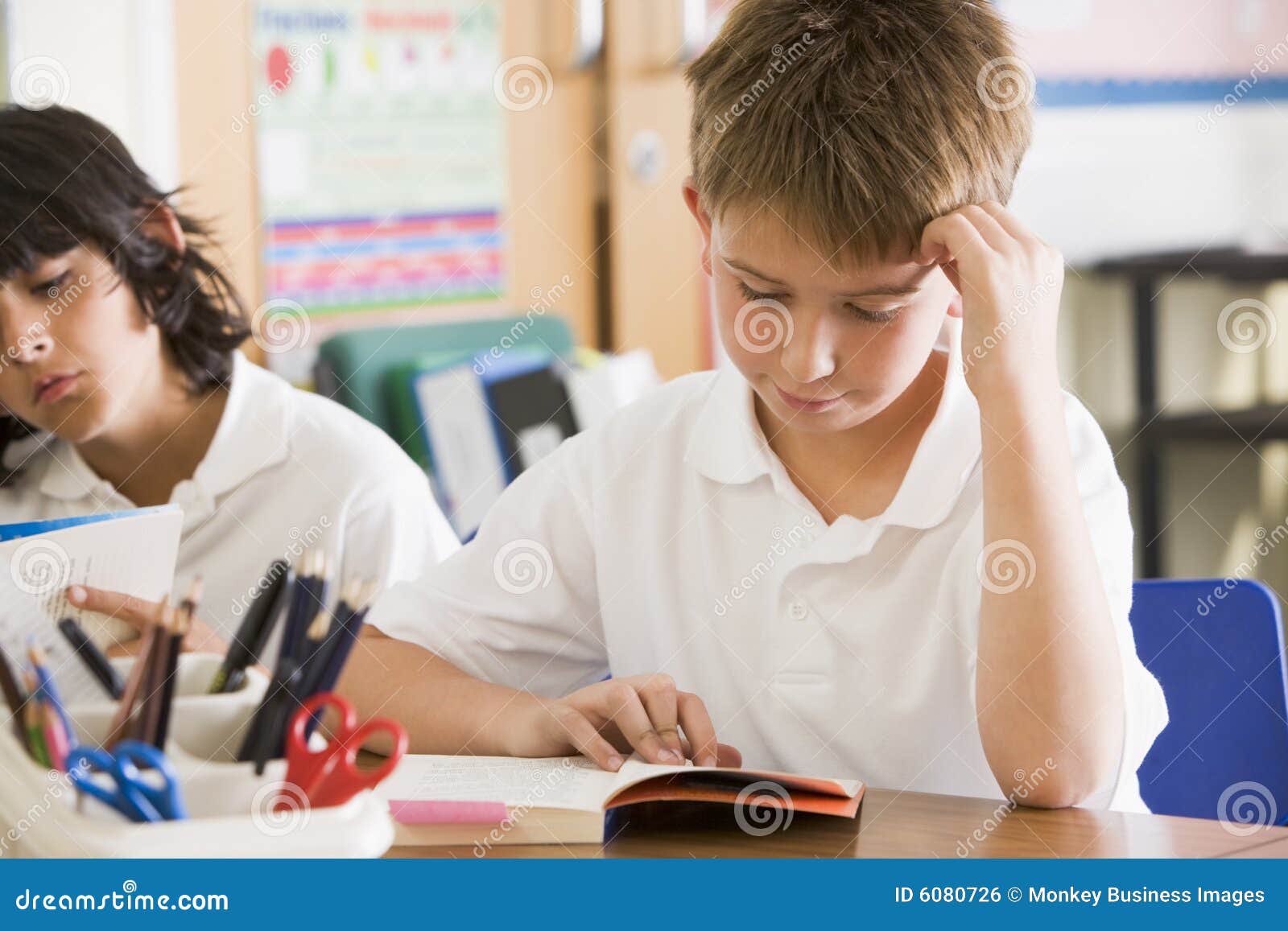 Schoolchildren Reading Books in Class Stock Photo - Image of studying ...