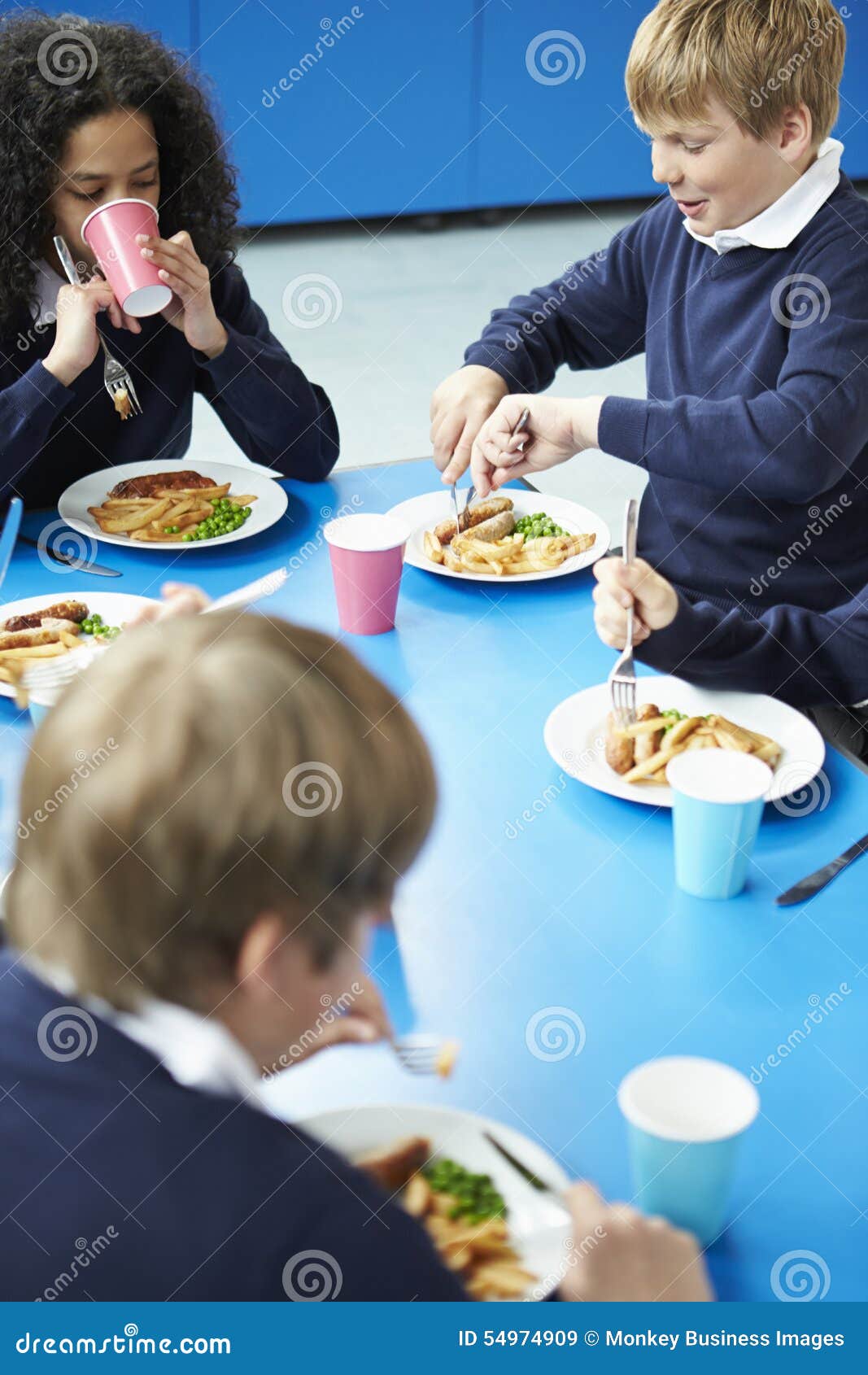 Schoolchildren Sitting at Table Eating Cooked Lunch Stock Image - Image ...