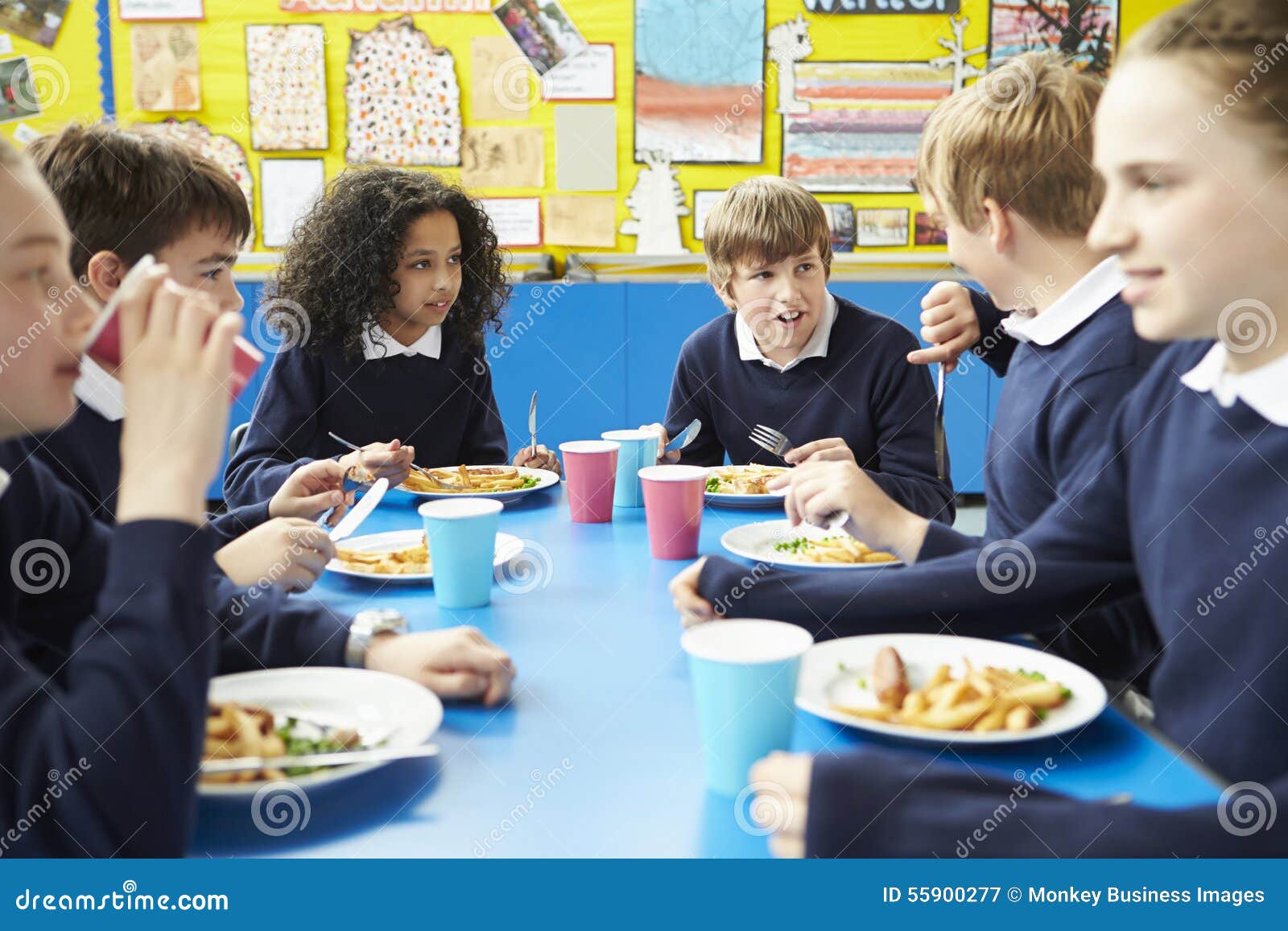 Schoolchildren Sitting at Table Eating Cooked Lunch Stock Image - Image ...