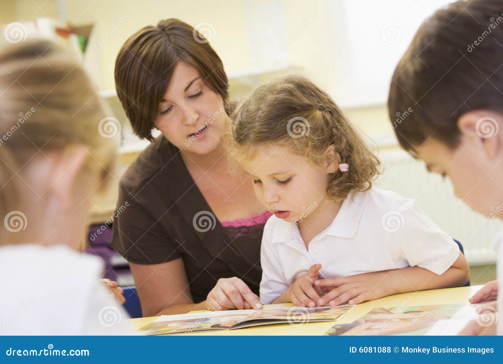 Schoolchildren and Their Teacher Reading in Class Stock Photo - Image ...