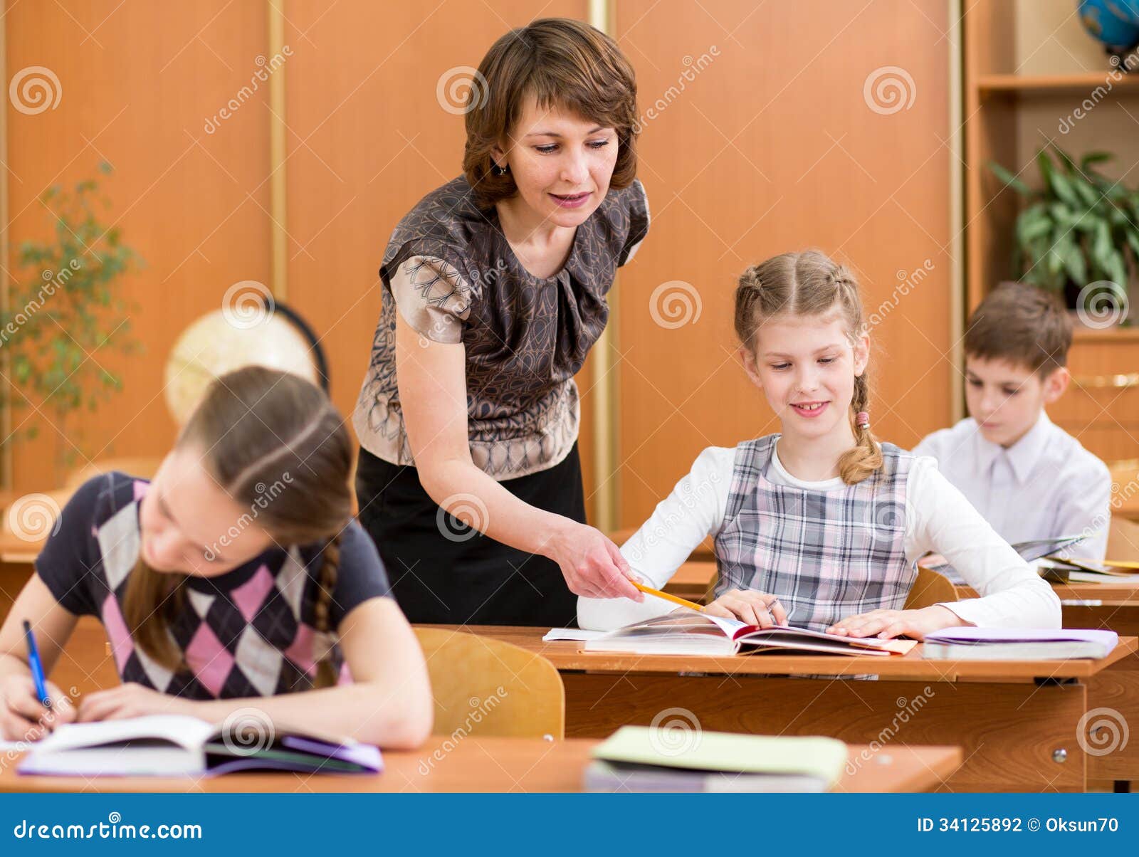 Schoolchildren Work at Lesson. Teacher Controlling Learning Process ...