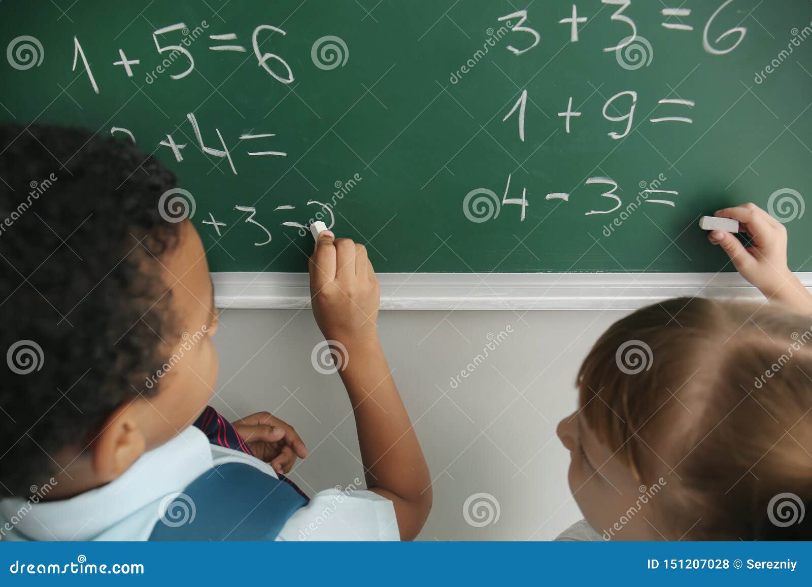 Schoolchildren Writing on Chalkboard in Classroom during Math Lesson ...