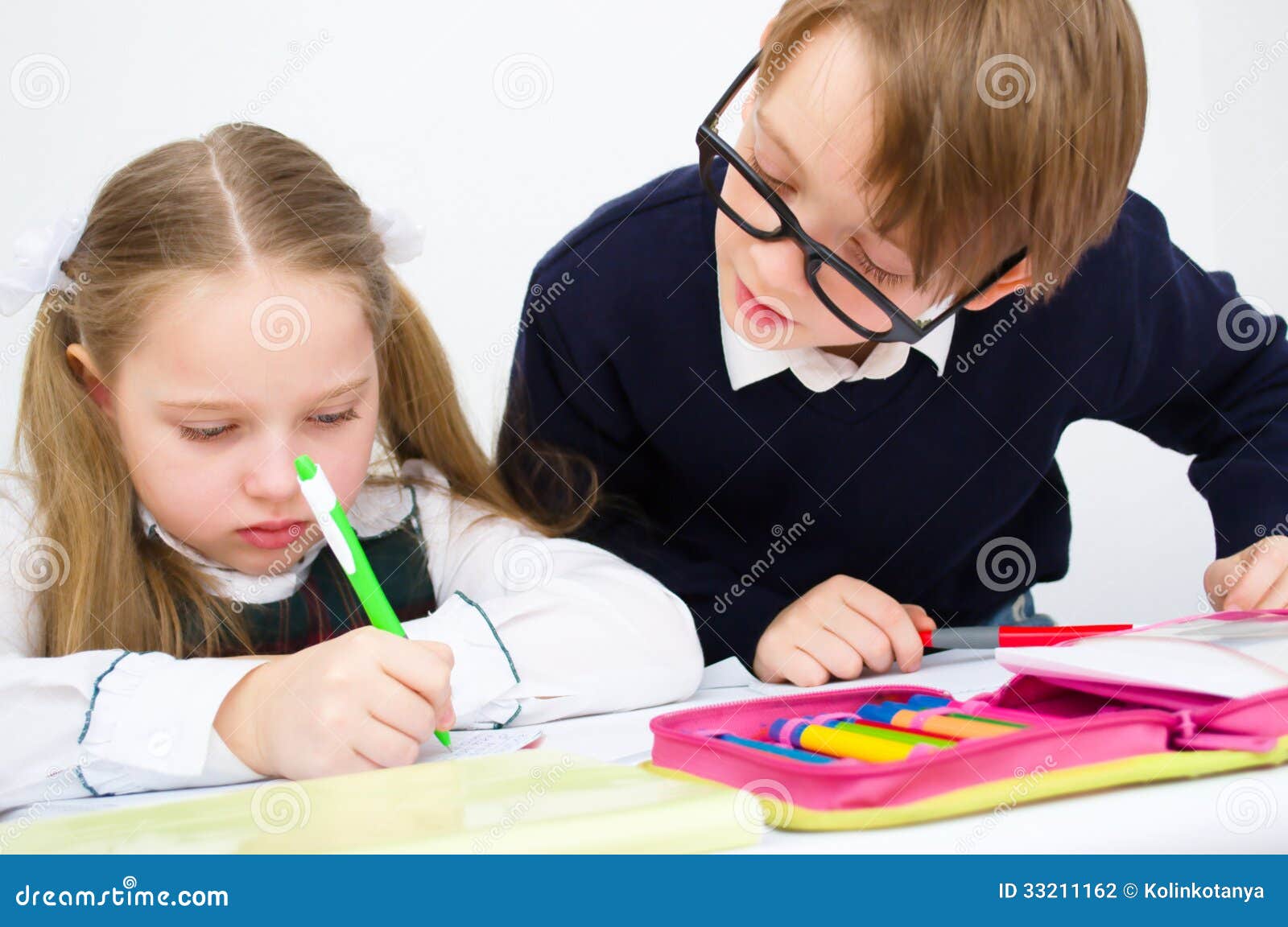 Schoolchildren Writing in Workbook Stock Photo - Image of cute, friends ...
