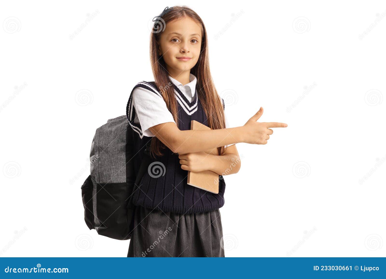 Schoolgirl with a Backpack Holding a Book and Pointing Stock Image ...