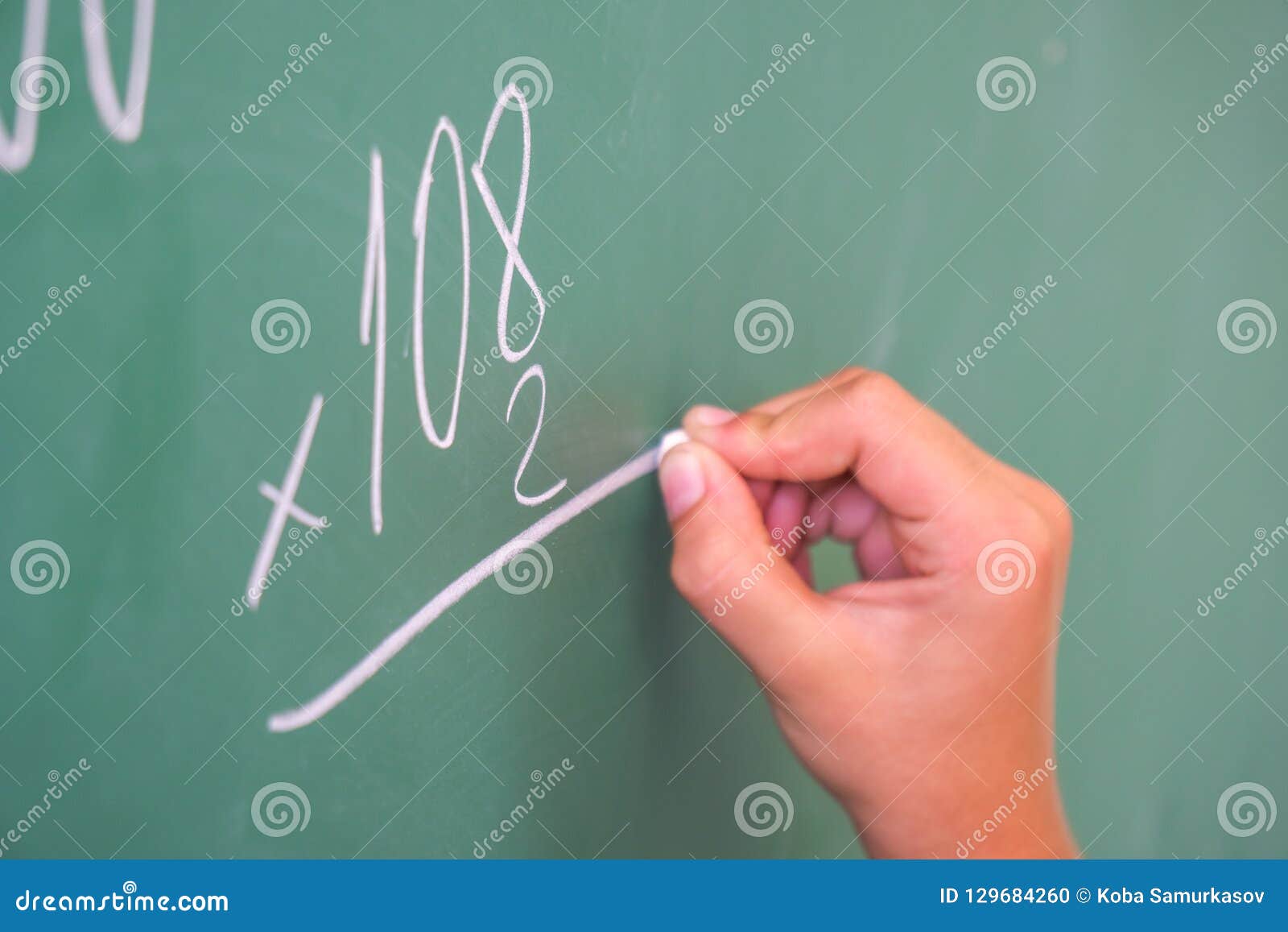 Schoolgirl with Chalk at the Blackboard Solves a Math Problem Stock ...