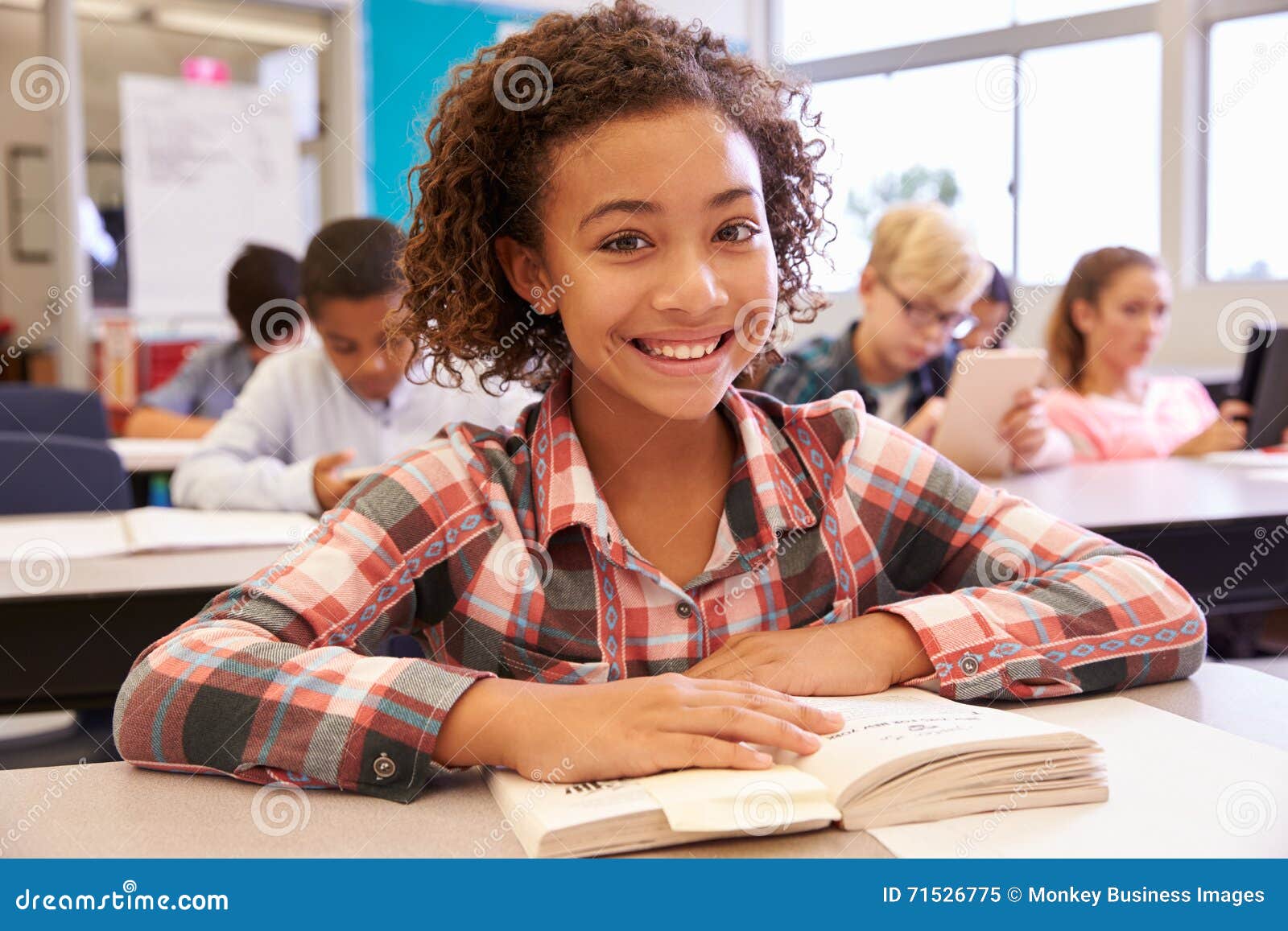 Schoolgirl at Desk in Elementary School Looking To Camera Stock Image ...