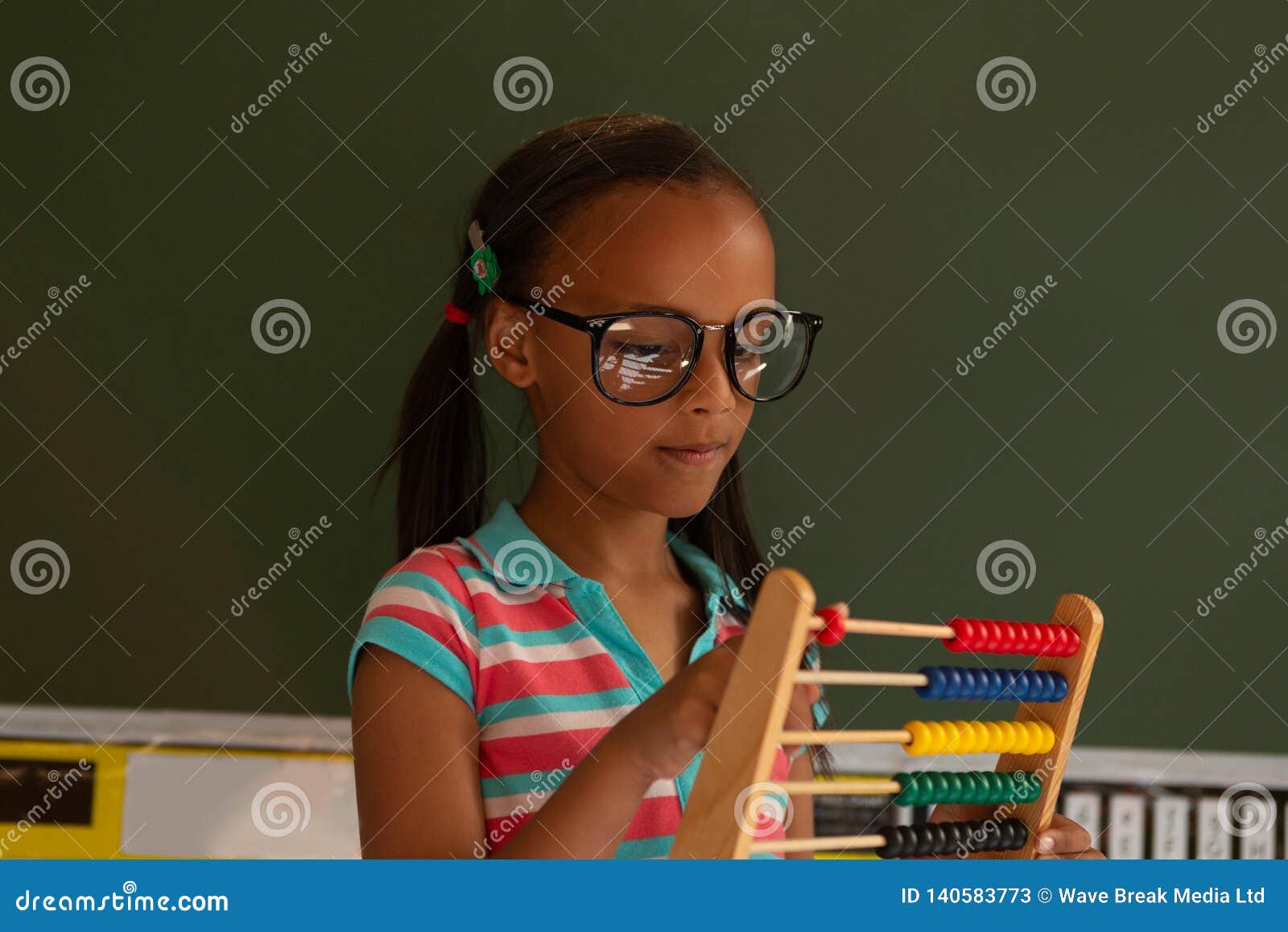 Schoolgirl Learning Mathematics with Abacus in the Classroom Stock ...