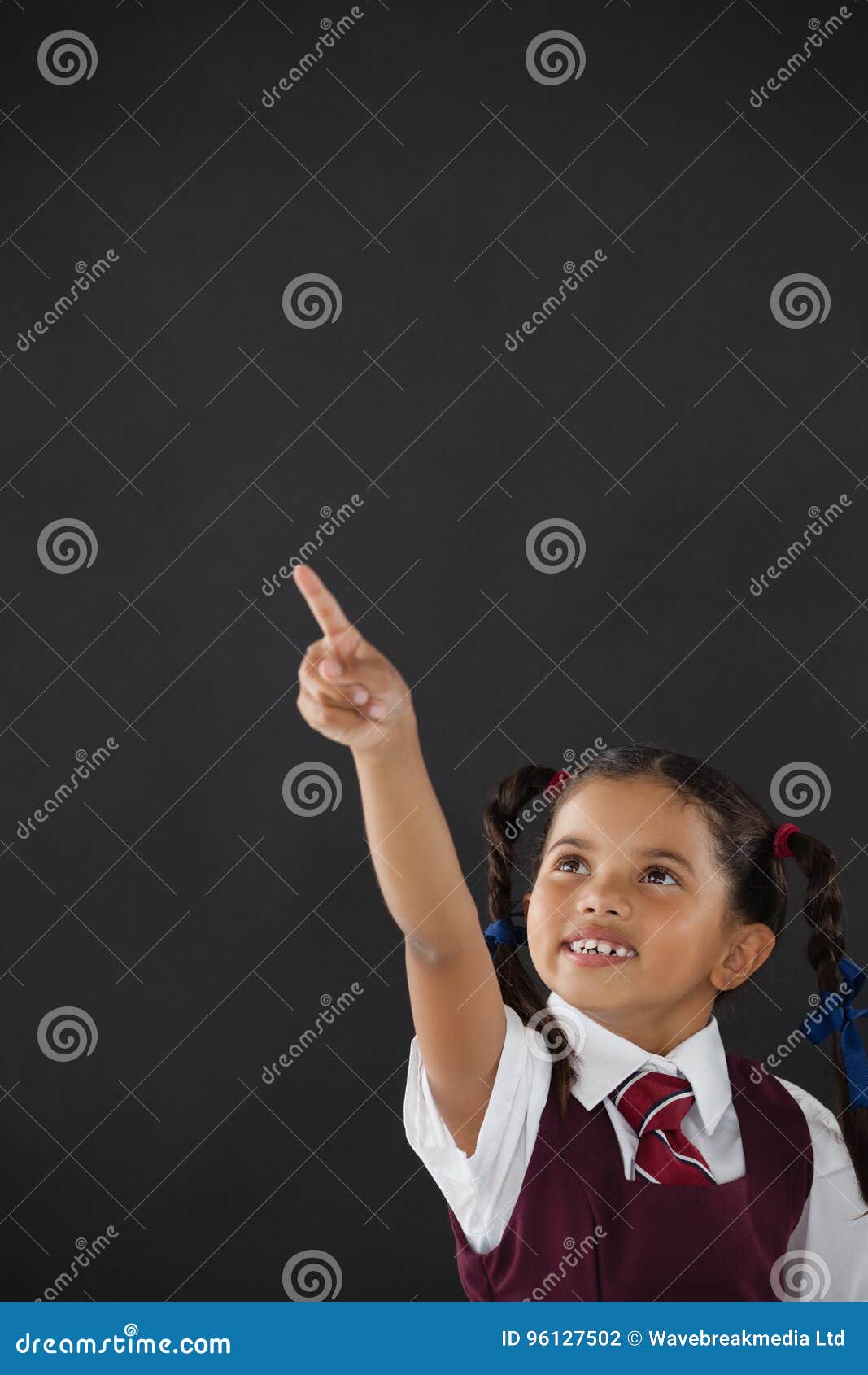 Schoolgirl Pointing Against Blackboard in Classroom Stock Photo - Image ...