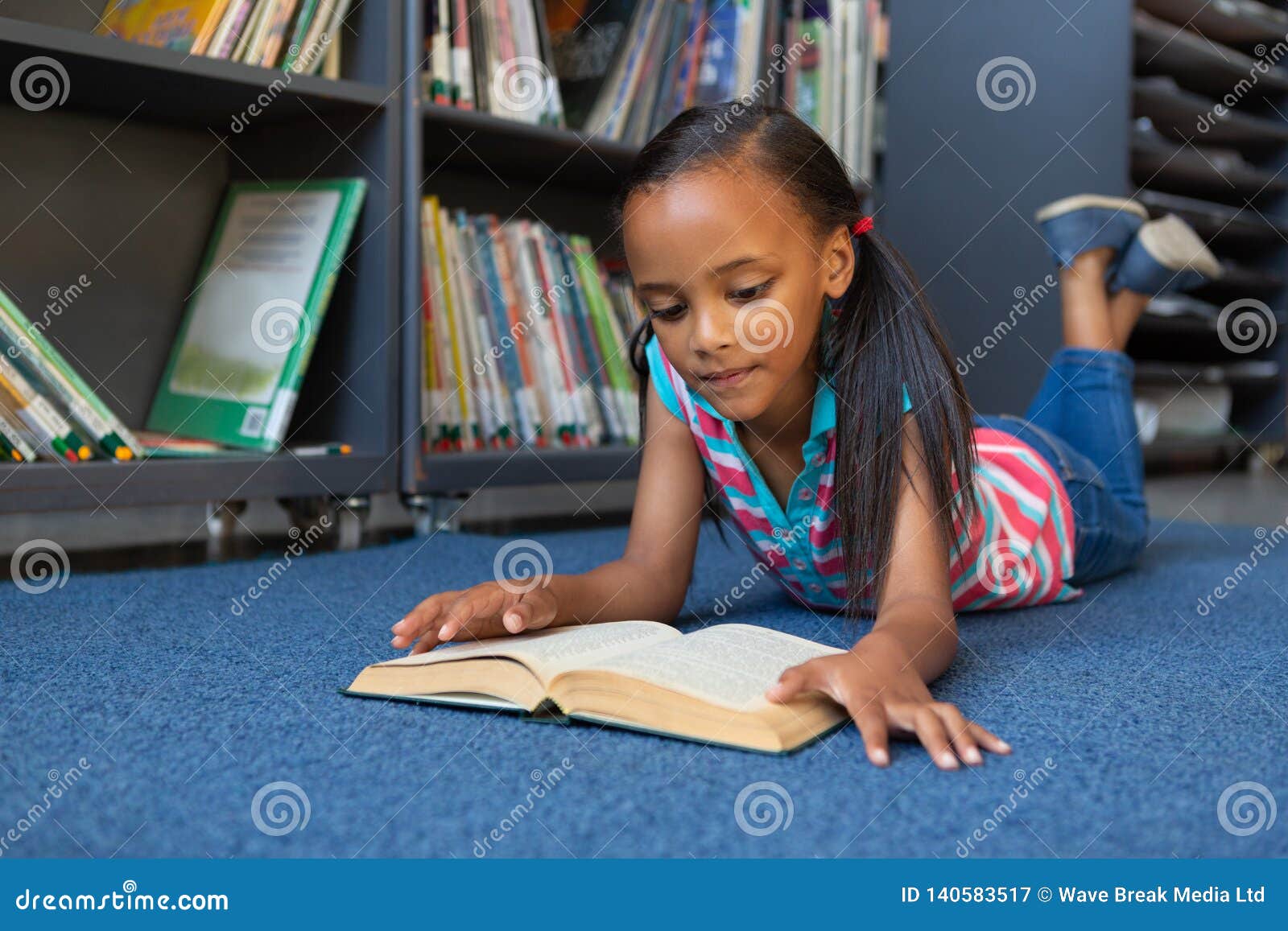 Schoolgirl Reading a Book in the Library Stock Image - Image of ...