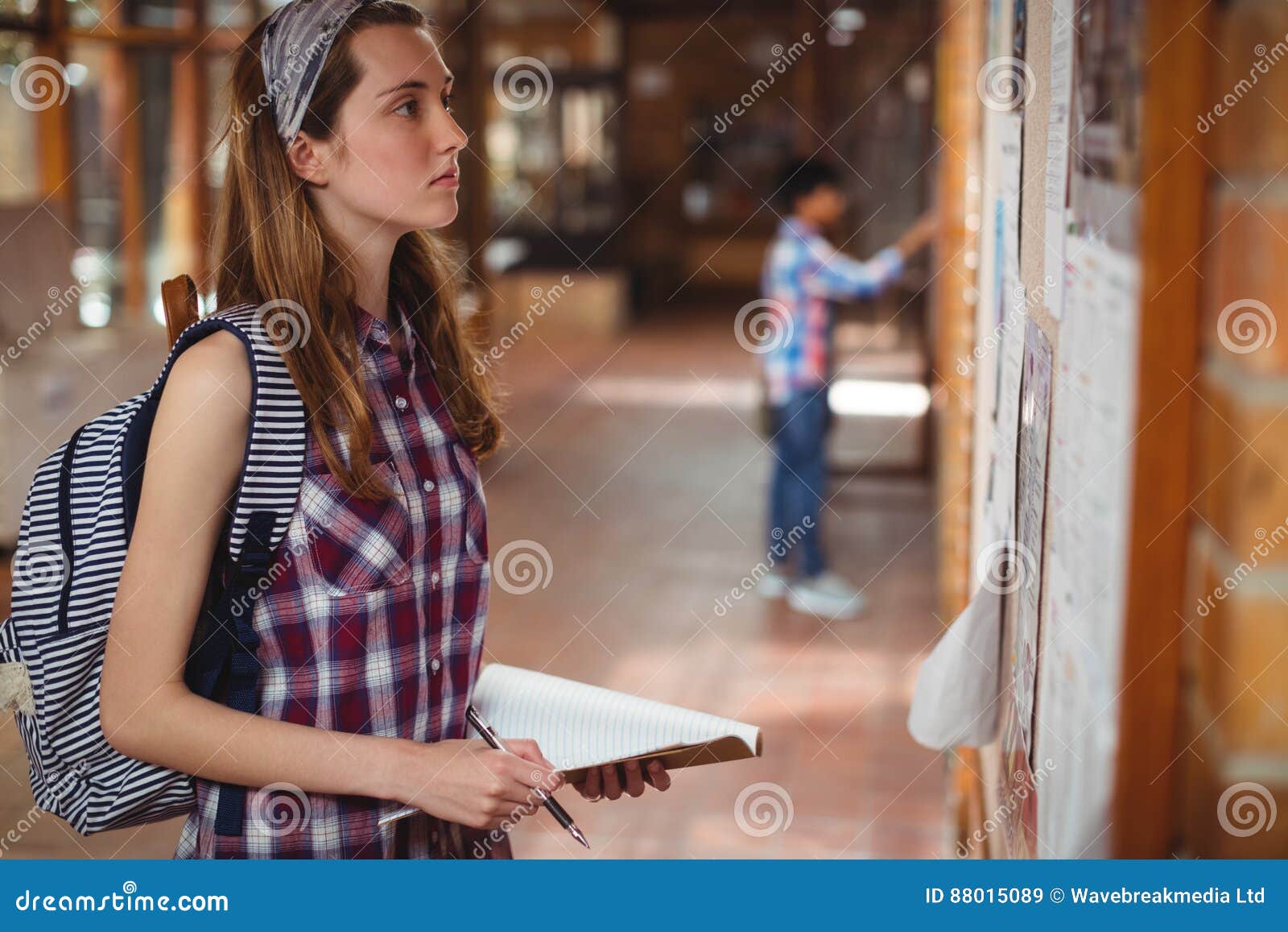Schoolgirl Reading Notice Board in Corridor Stock Image - Image of ...