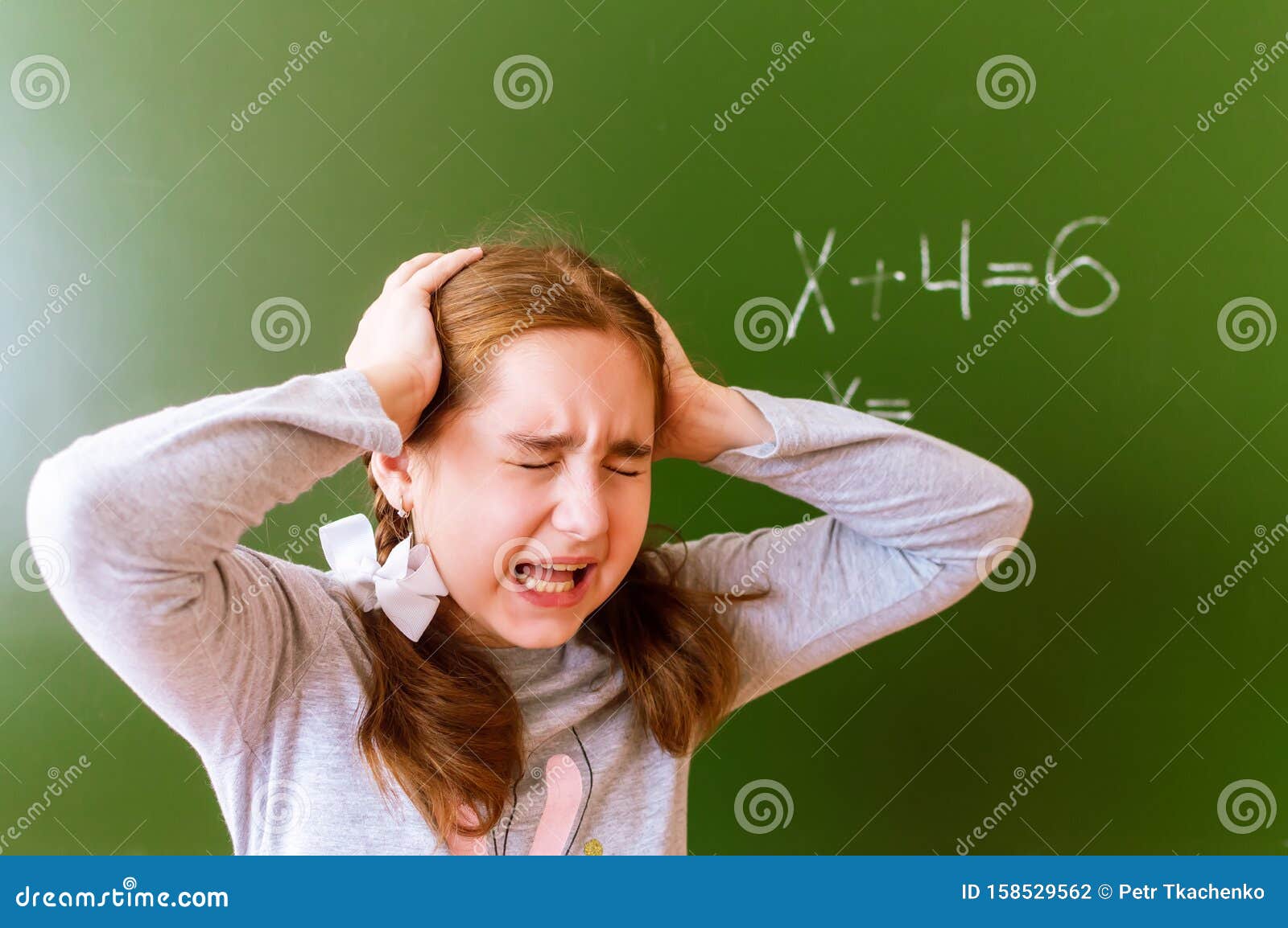 Schoolgirl Solves a Math Problem on the Blackboard during the Lesson ...