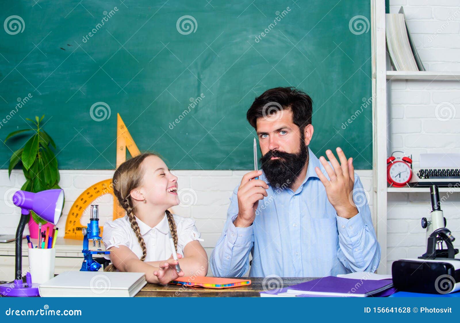 Schoolgirl Study Textbook. Father And Daughter Study In Classroom ...
