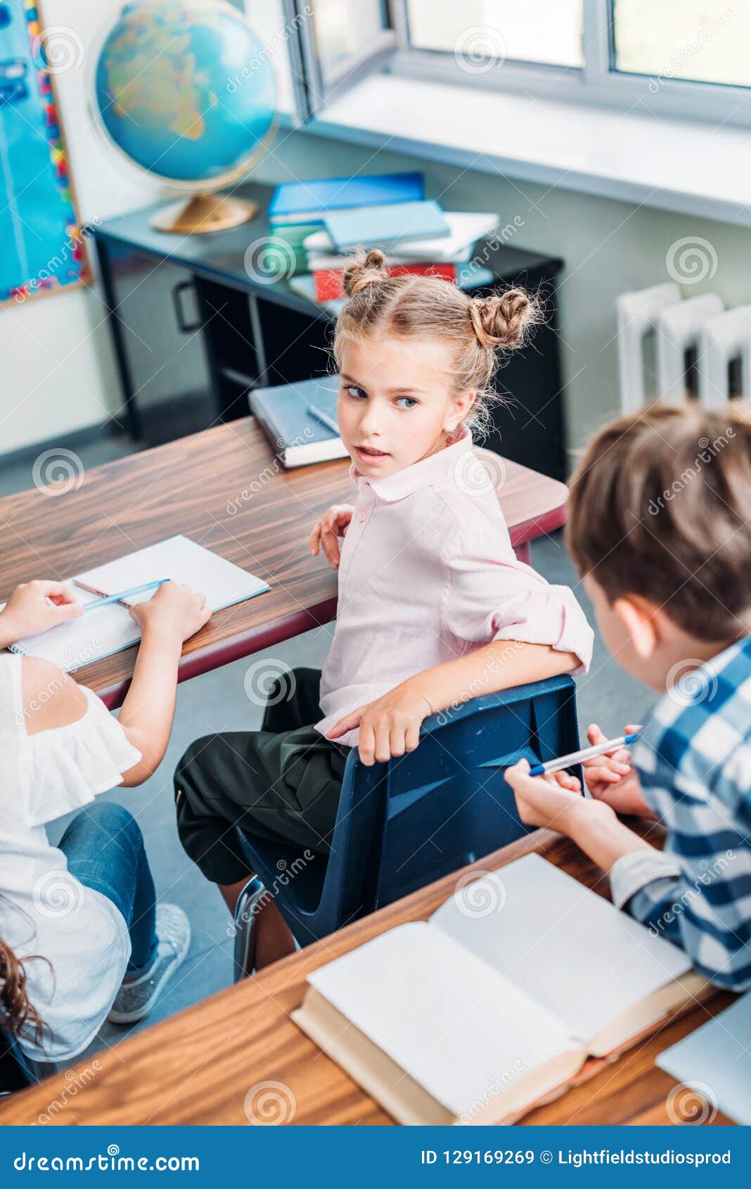 Adorable Schoolgirl Looking Back and Talking Stock Image - Image of ...