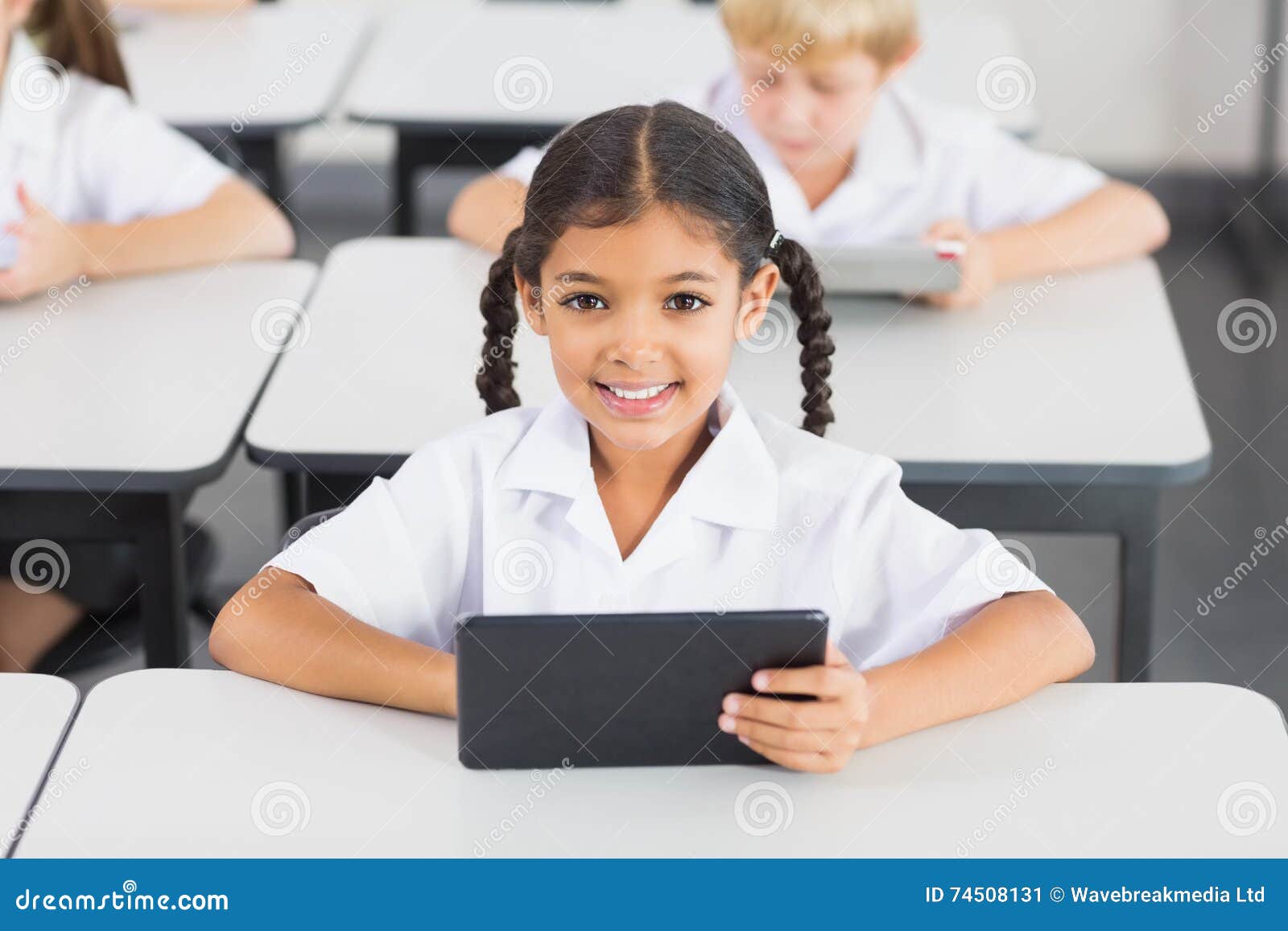 Schoolgirl Using Digital Tablet in Classroom Stock Image - Image of ...