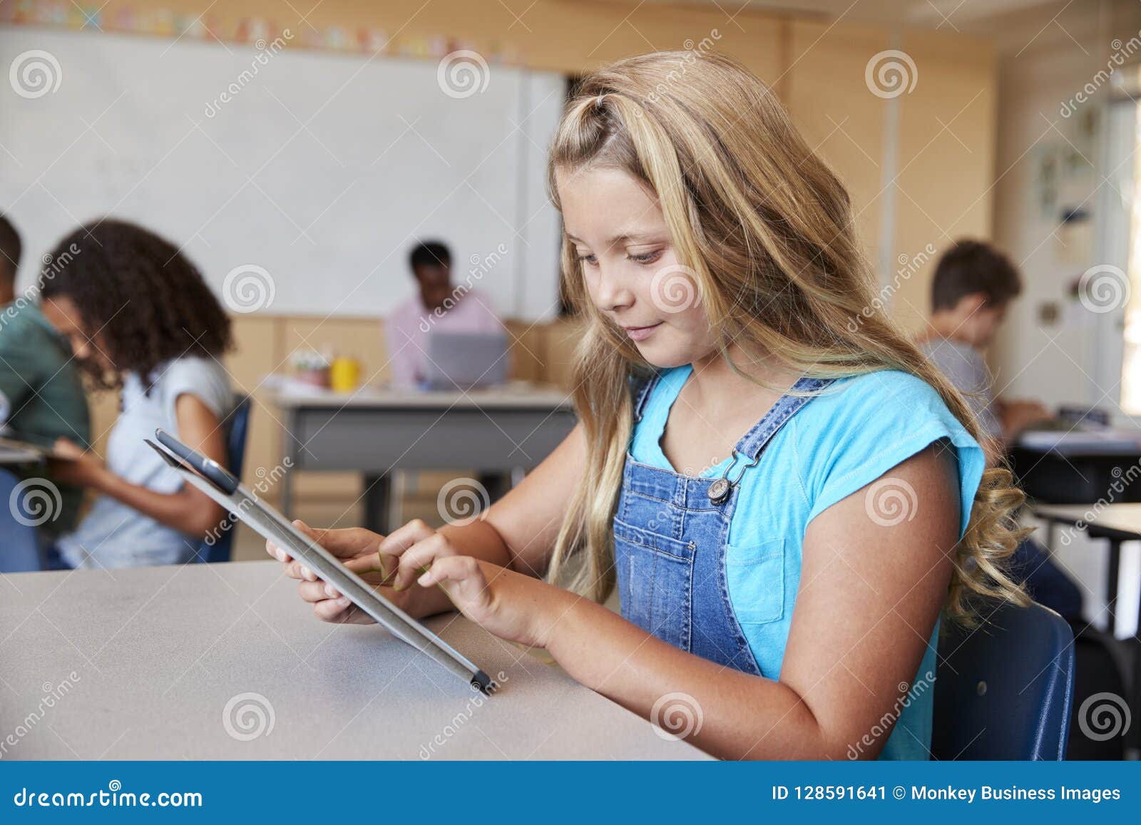 Schoolgirl Using Tablet in Elementary School Class, Close Up Stock ...
