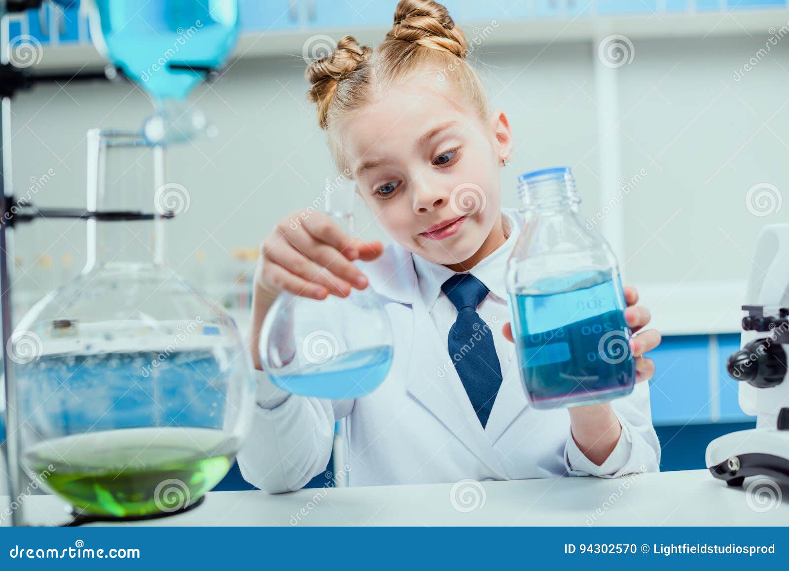 Schoolgirl in White Coat Making Experiment with Reagents Stock Photo ...