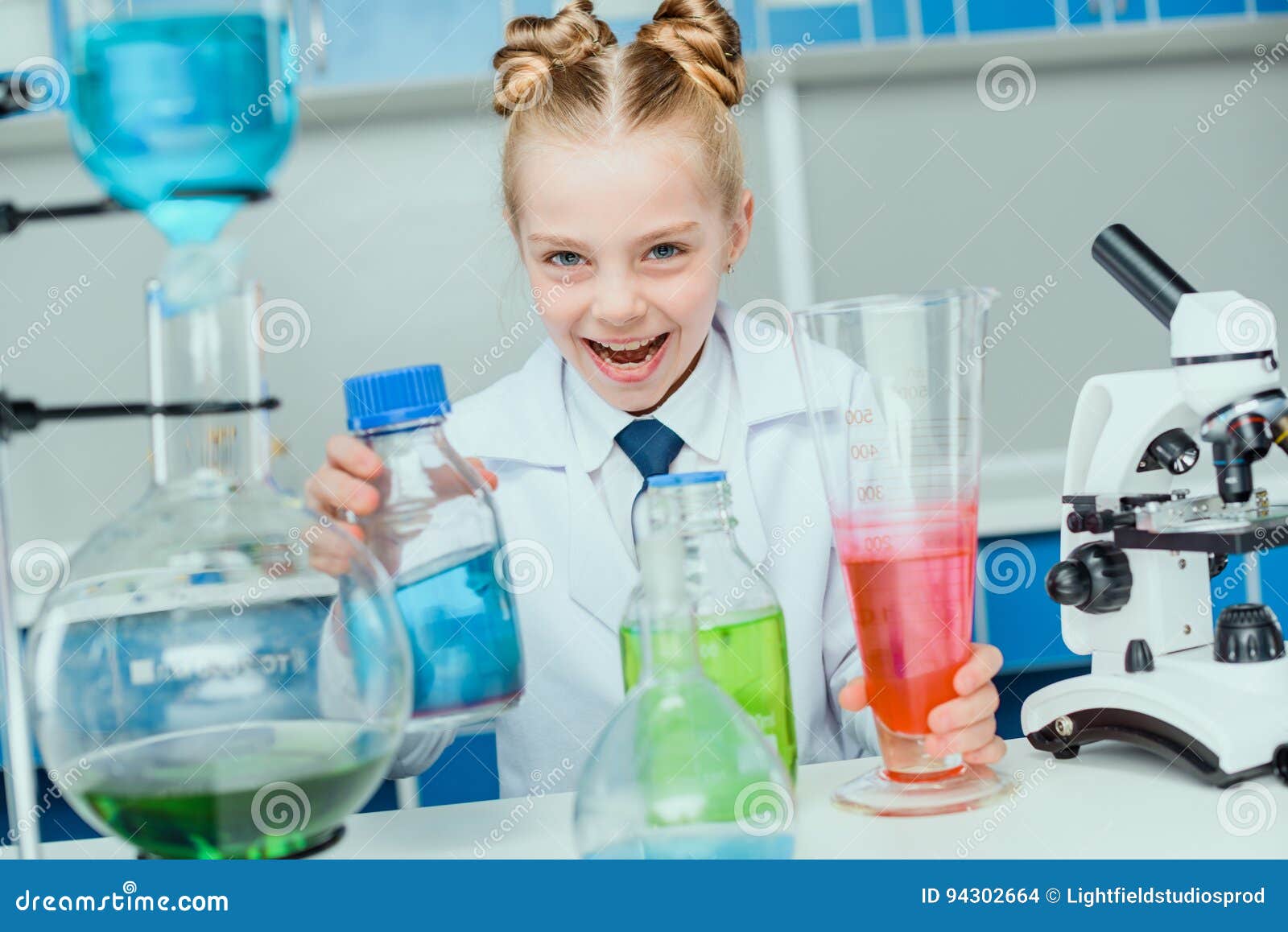Schoolgirl in White Coat Making Experiment with Reagents Stock Photo ...