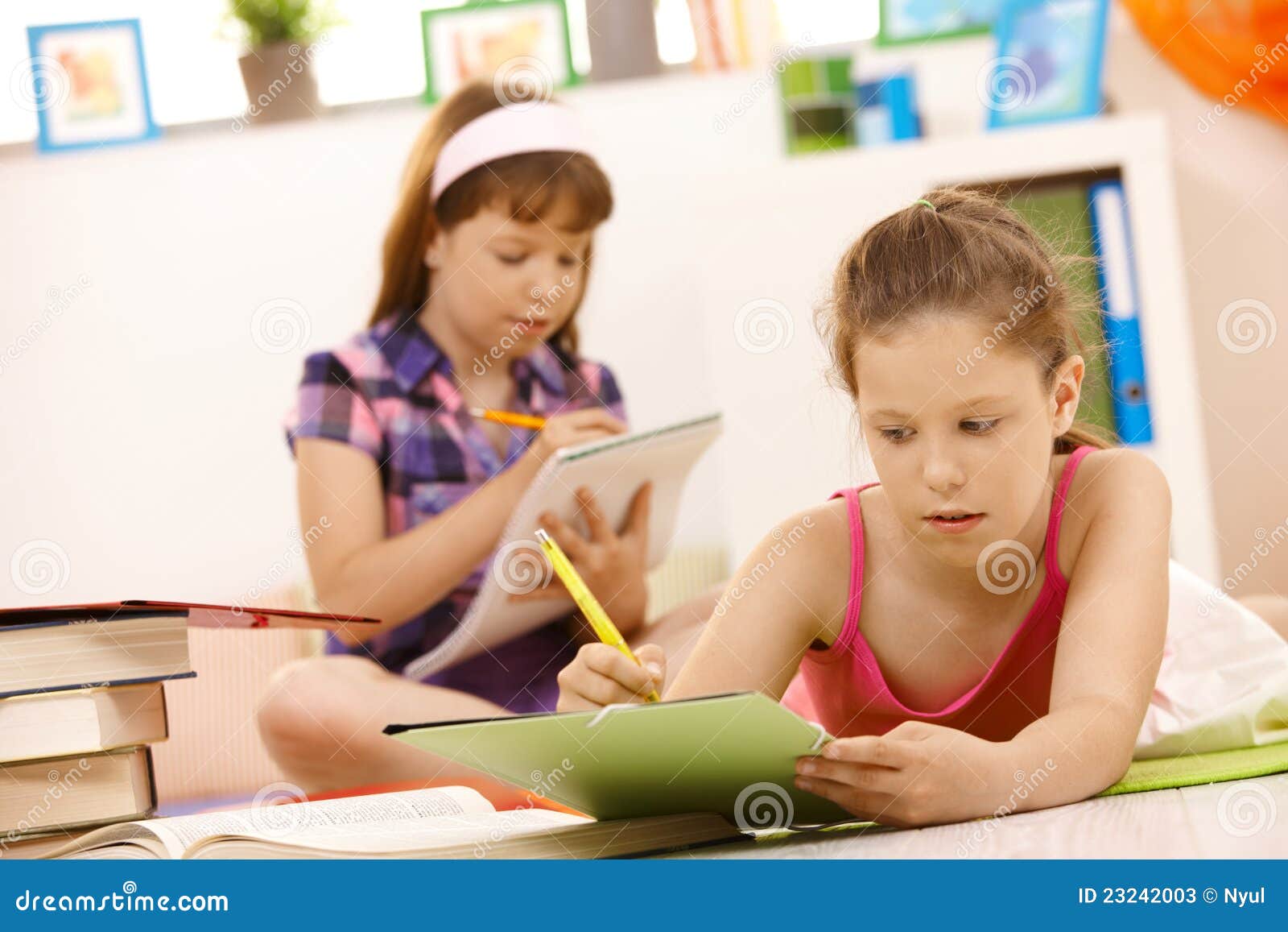 Schoolgirls doing homework stock image. Image of books - 23242003
