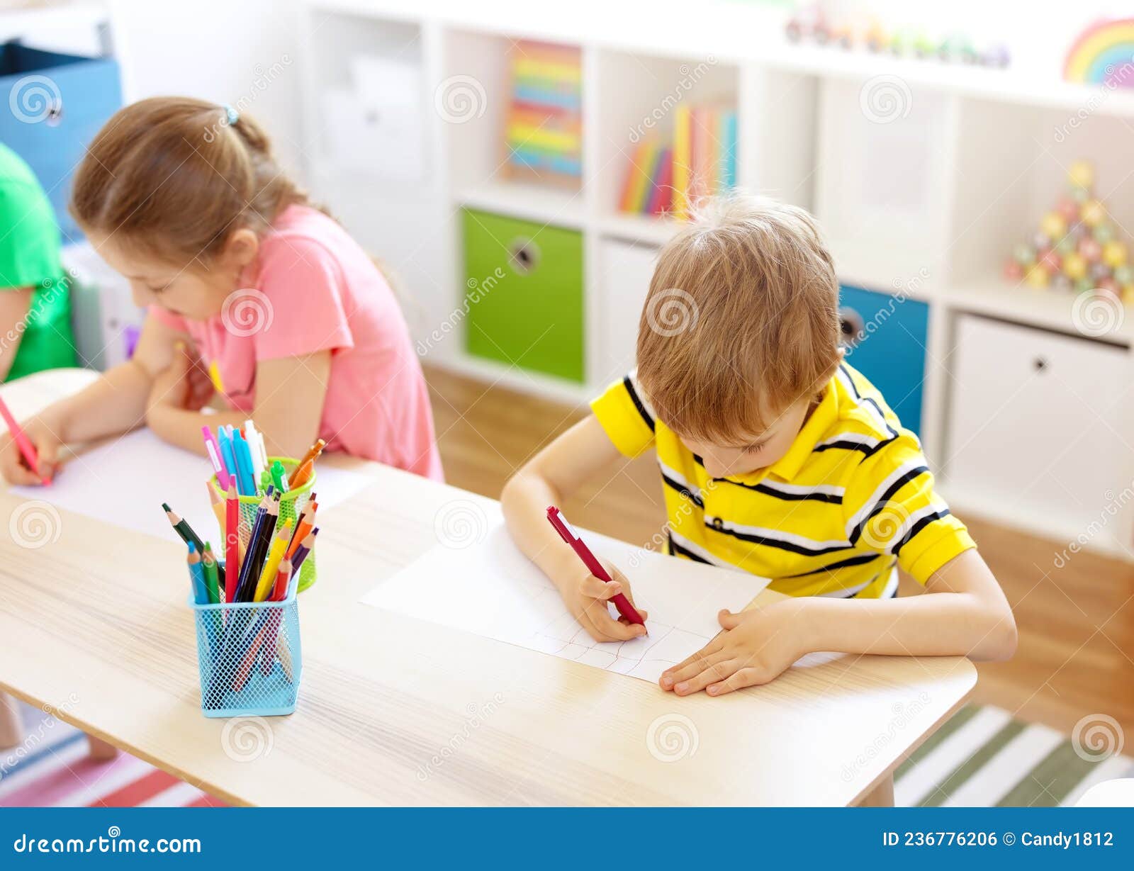 Schoolkids in the Classroom Sitting at the Tables and Writing a Lesson ...