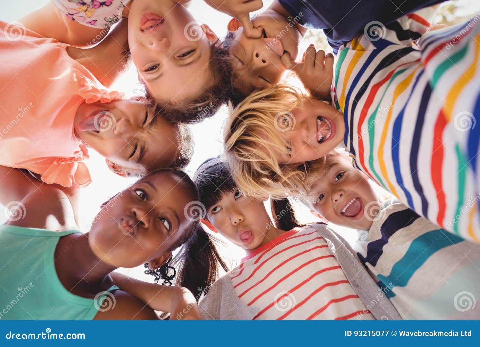 Schoolkids forming huddle stock image. Image of lifestyle - 93215077