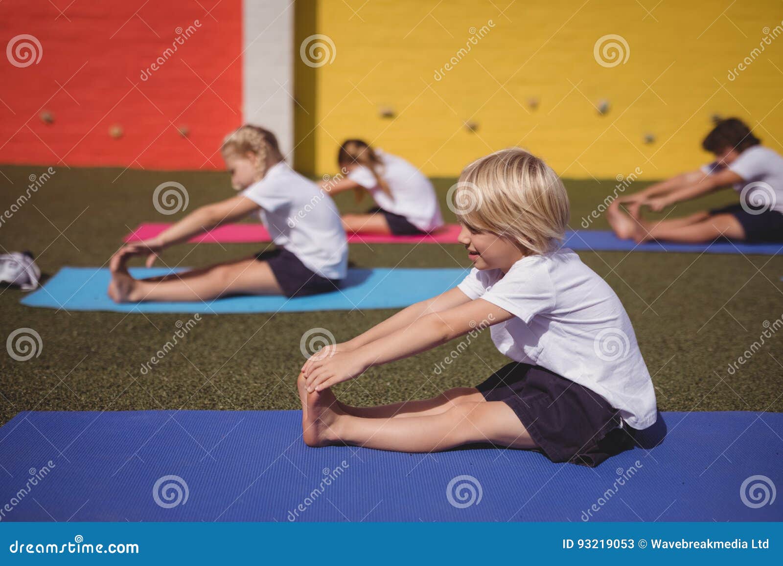 Schoolkids Performing Stretching Exercise Stock Image - Image of ...