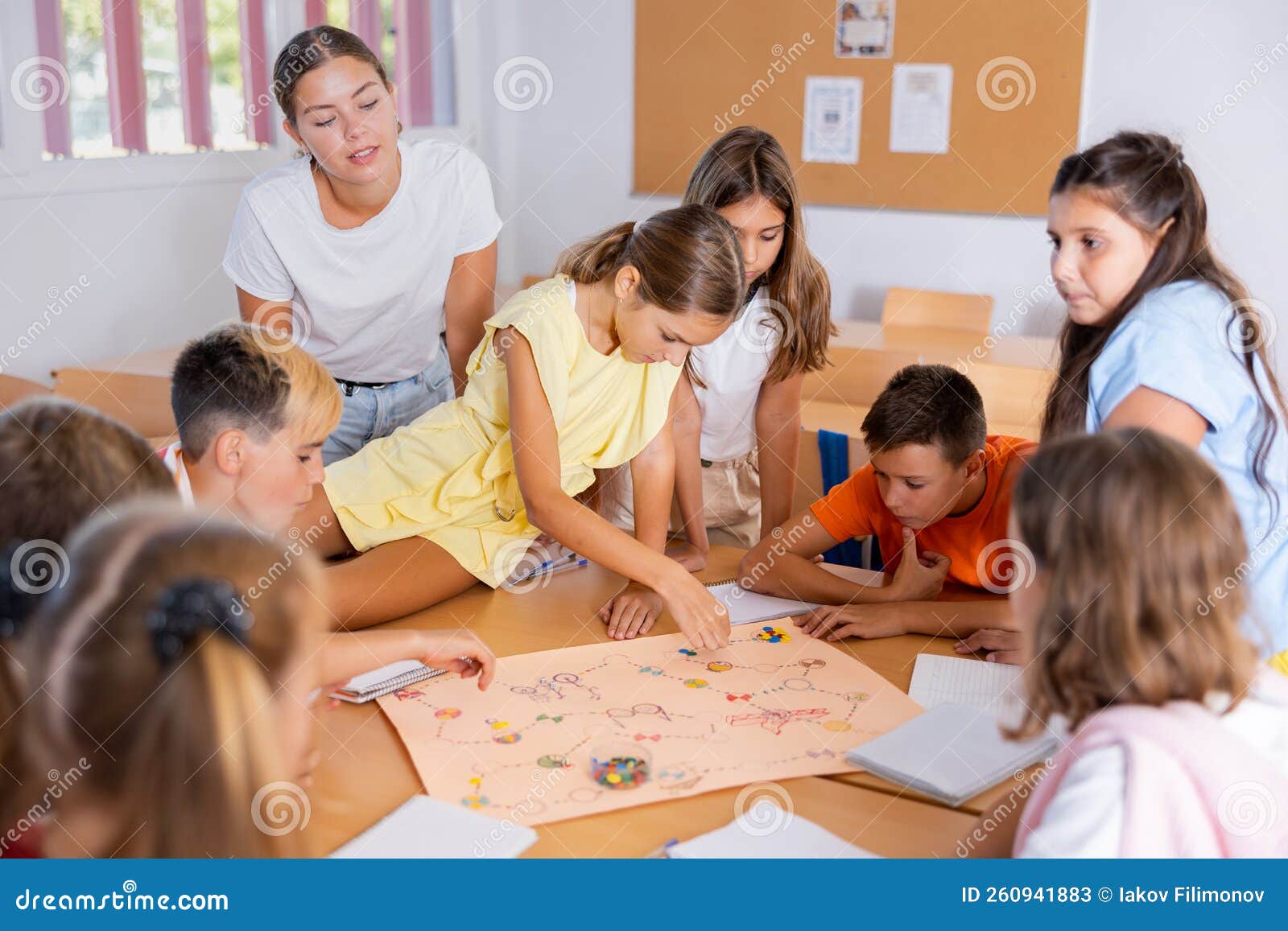 Schoolkids with Teacher Playing Educational Tabletop Game in Classroom ... Schoolkids with Teacher Playing Educational Tabletop Game in Classroom ...