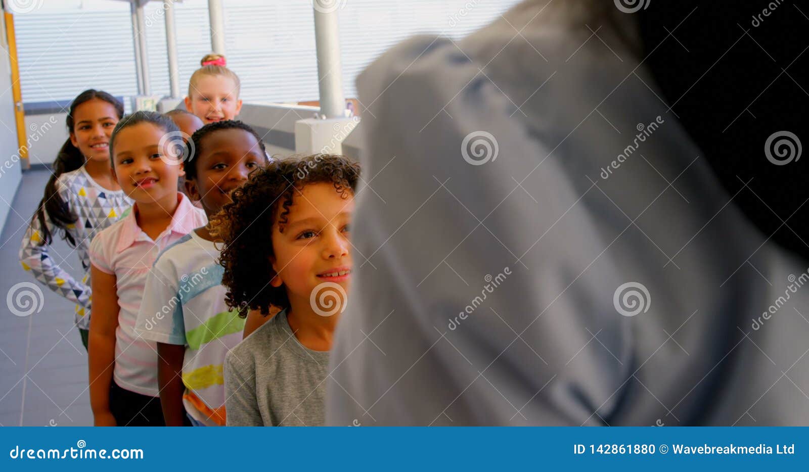 Schoolkids with Teacher Standing in Row in Hallway at School 4k Stock ...