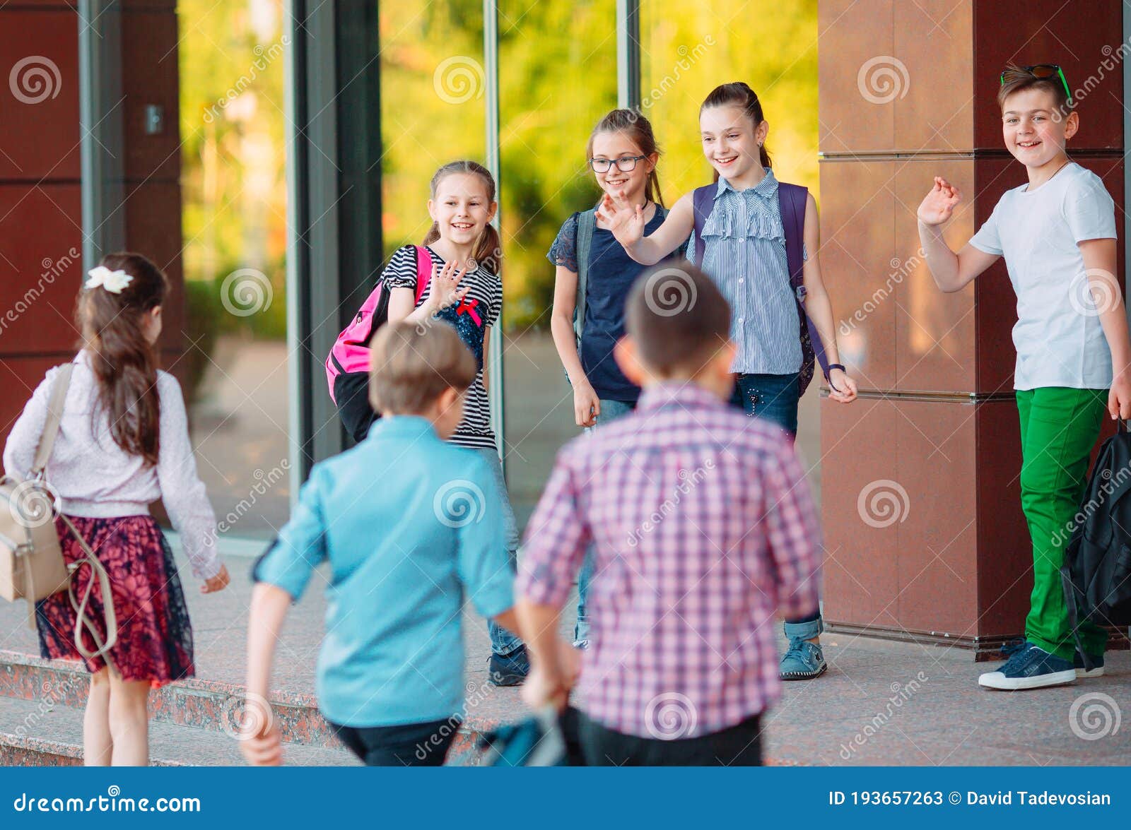 Schoolmates Go To School. Students Greet Each Other. Stock Image ...